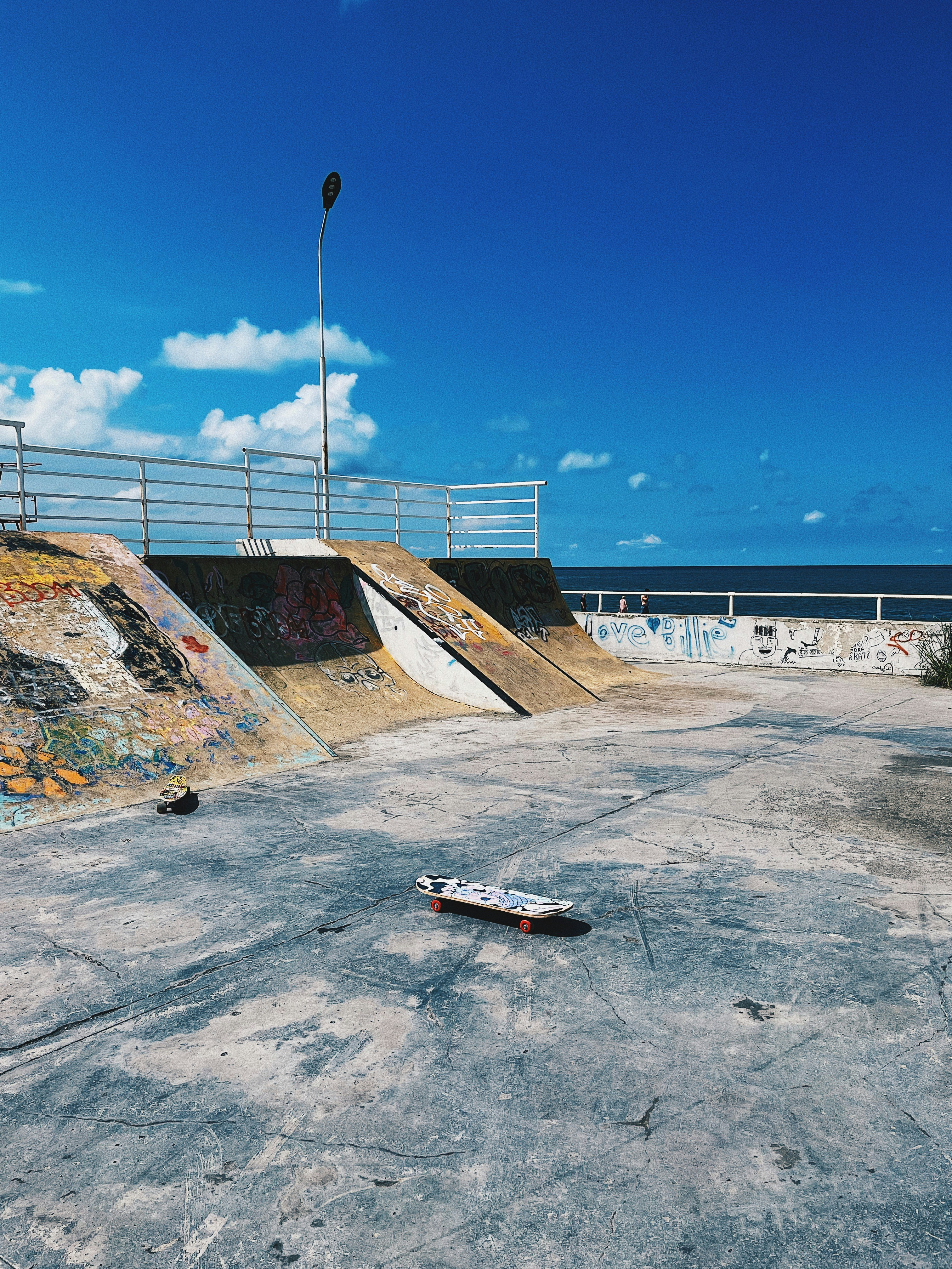 A skateboard laying on the ground in a skate park photo – Free Building ...