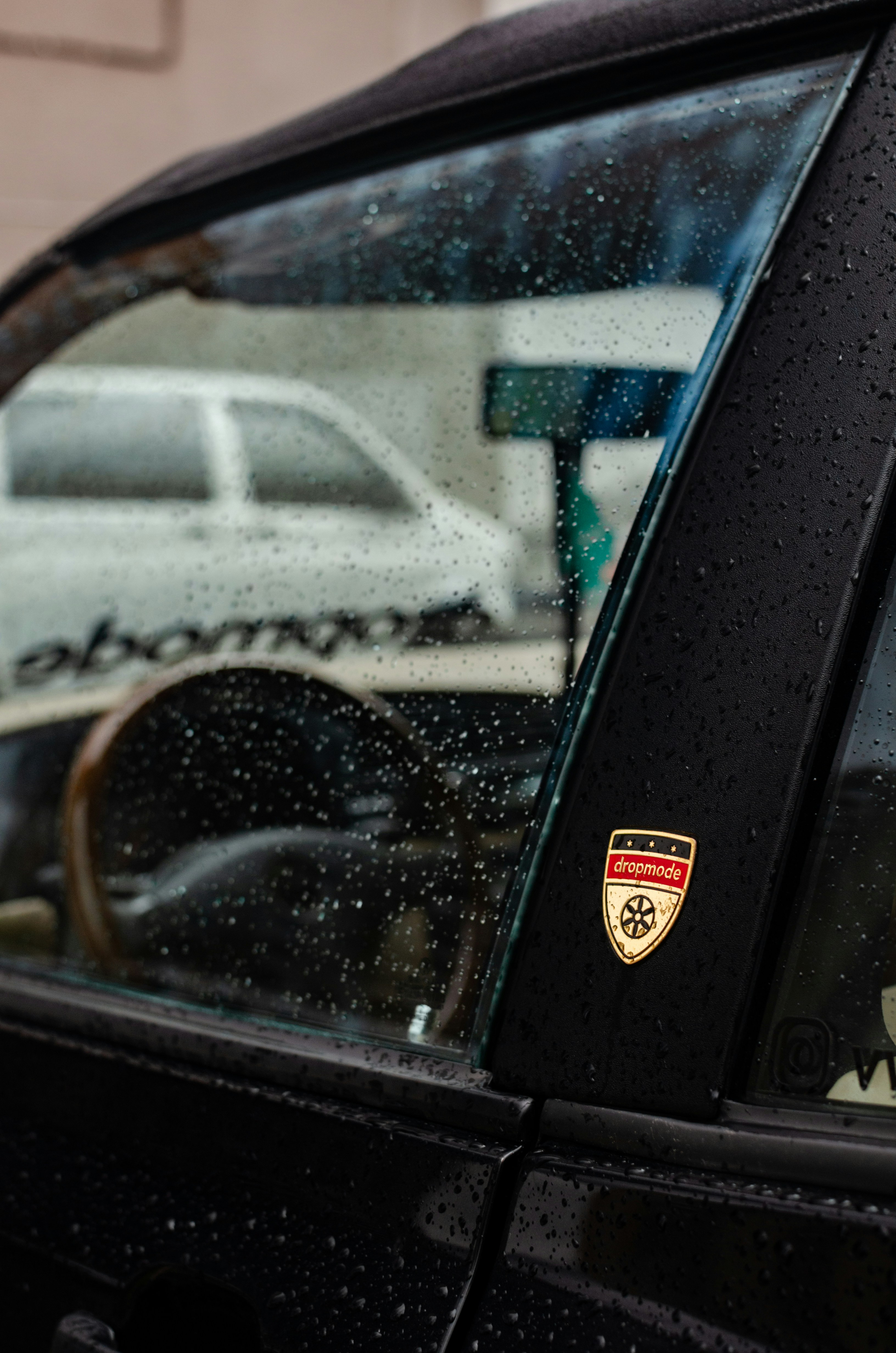 Rain-Kissed Car: A Glint of Badge in the Dark