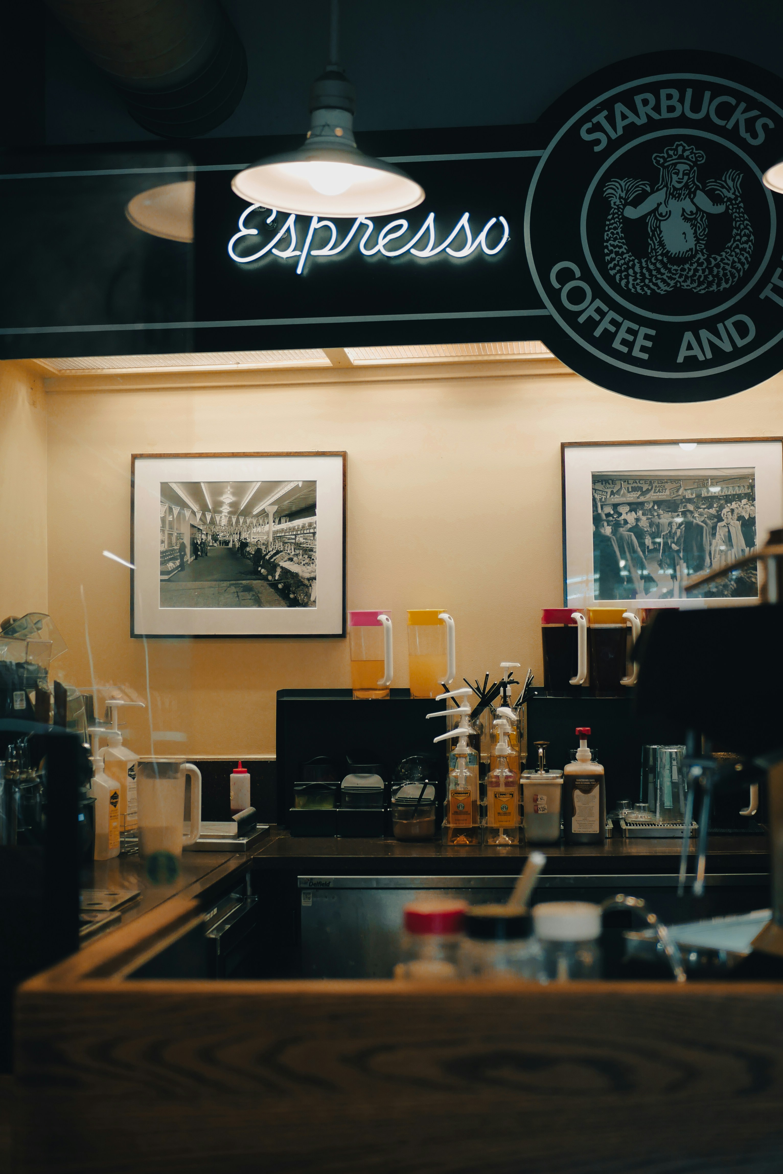 A coffee shop with a neon sign above the counter photo – Free Wa Image ...