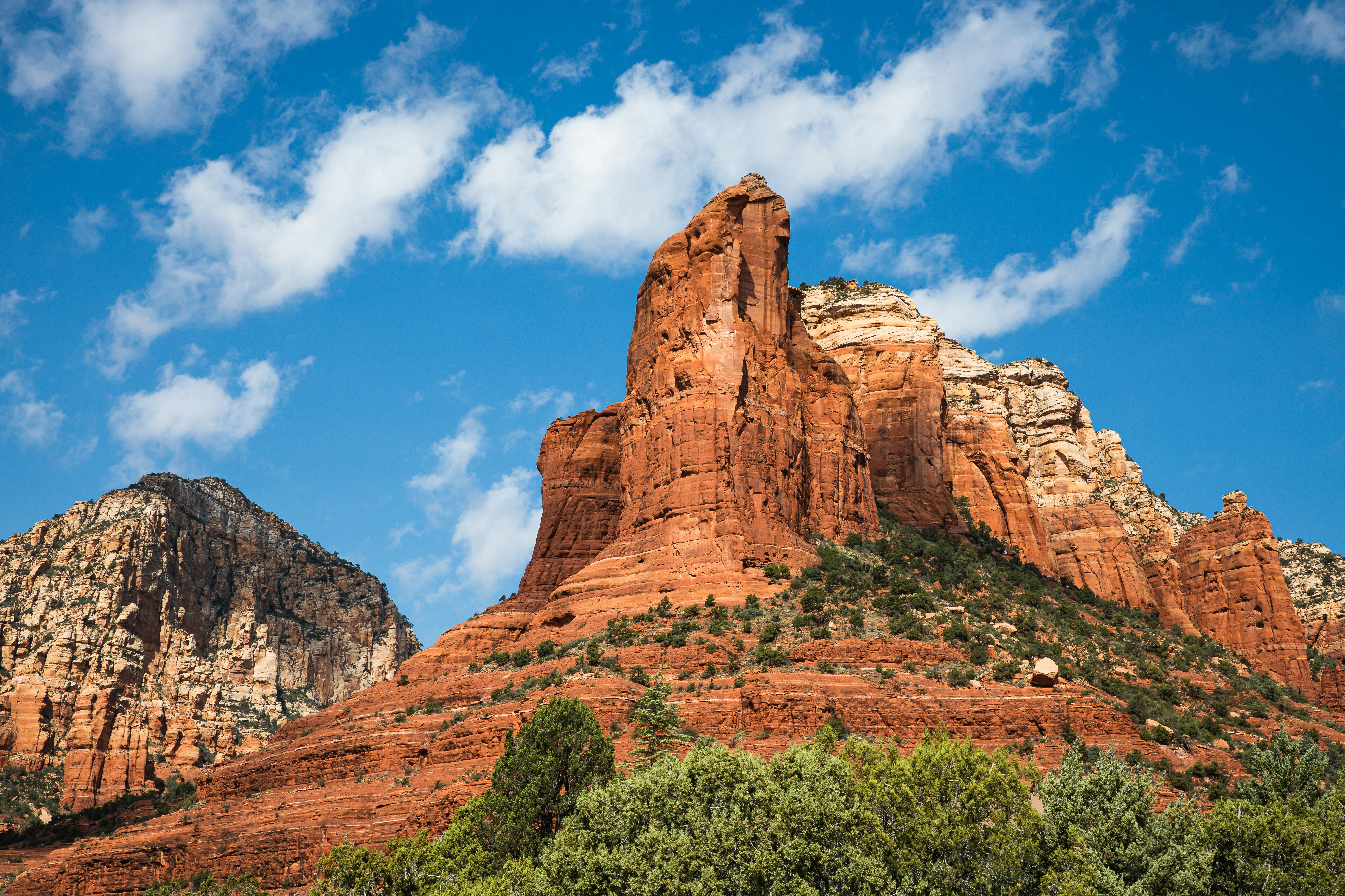A large red rock formation with a sky background photo – Free Brown ...