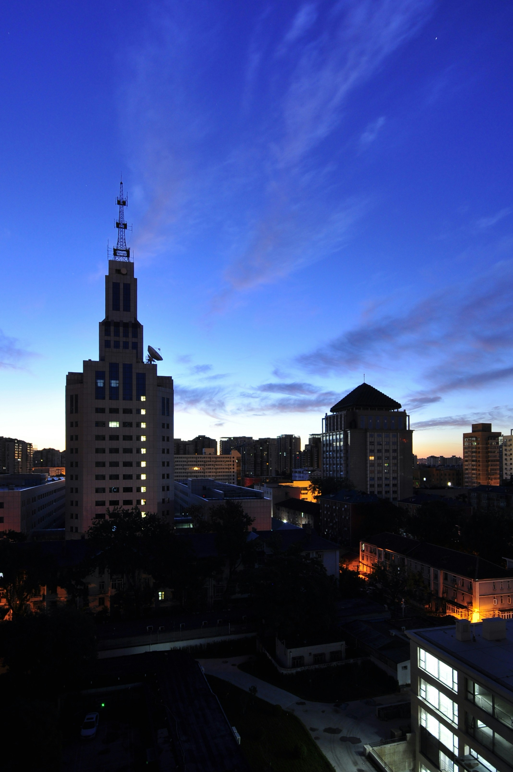 City Skyline at Dusk: A Tall Landmark Reaches into a Velvet Sky
