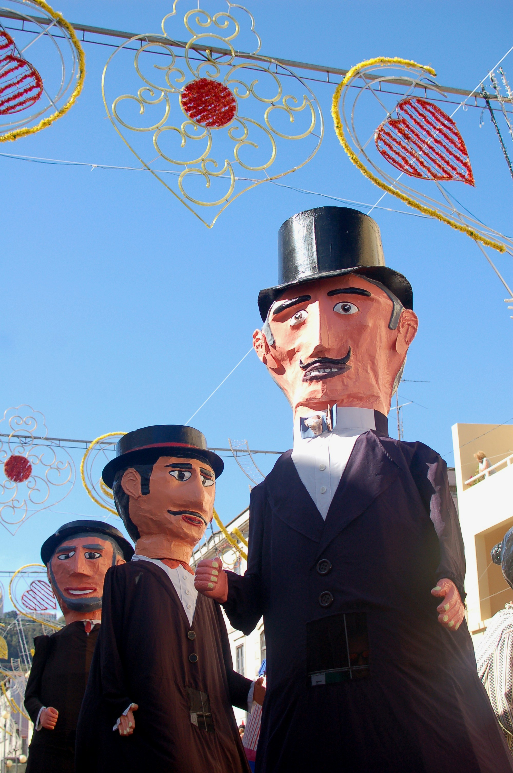 Gigantic Papercraft Dignitaries under Sky-Blue Day
