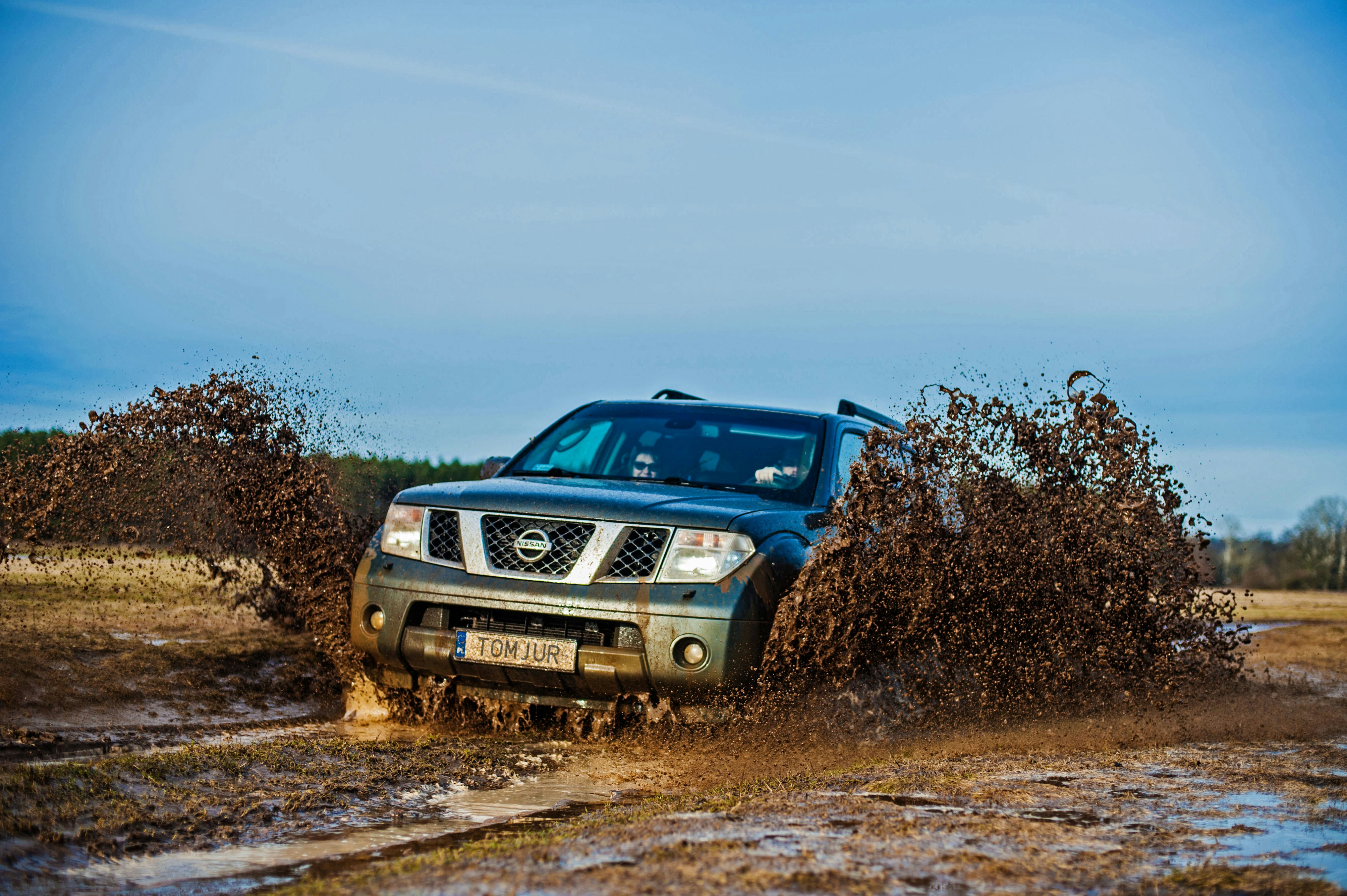 A truck driving through a puddle of mud photo – Free Offroad Image on ...