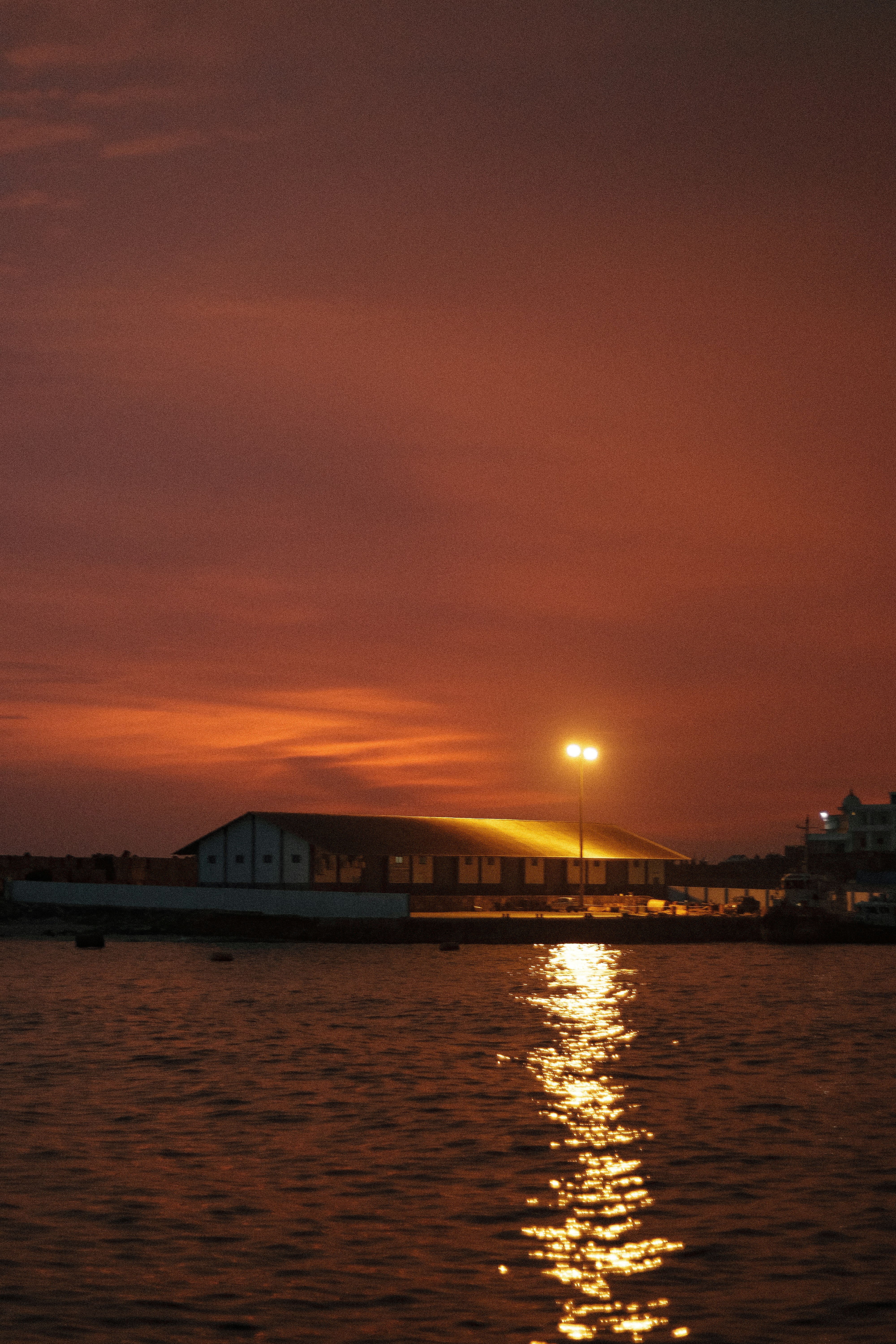 The sun is setting over a body of water photo – Free Sun and moon Image ...