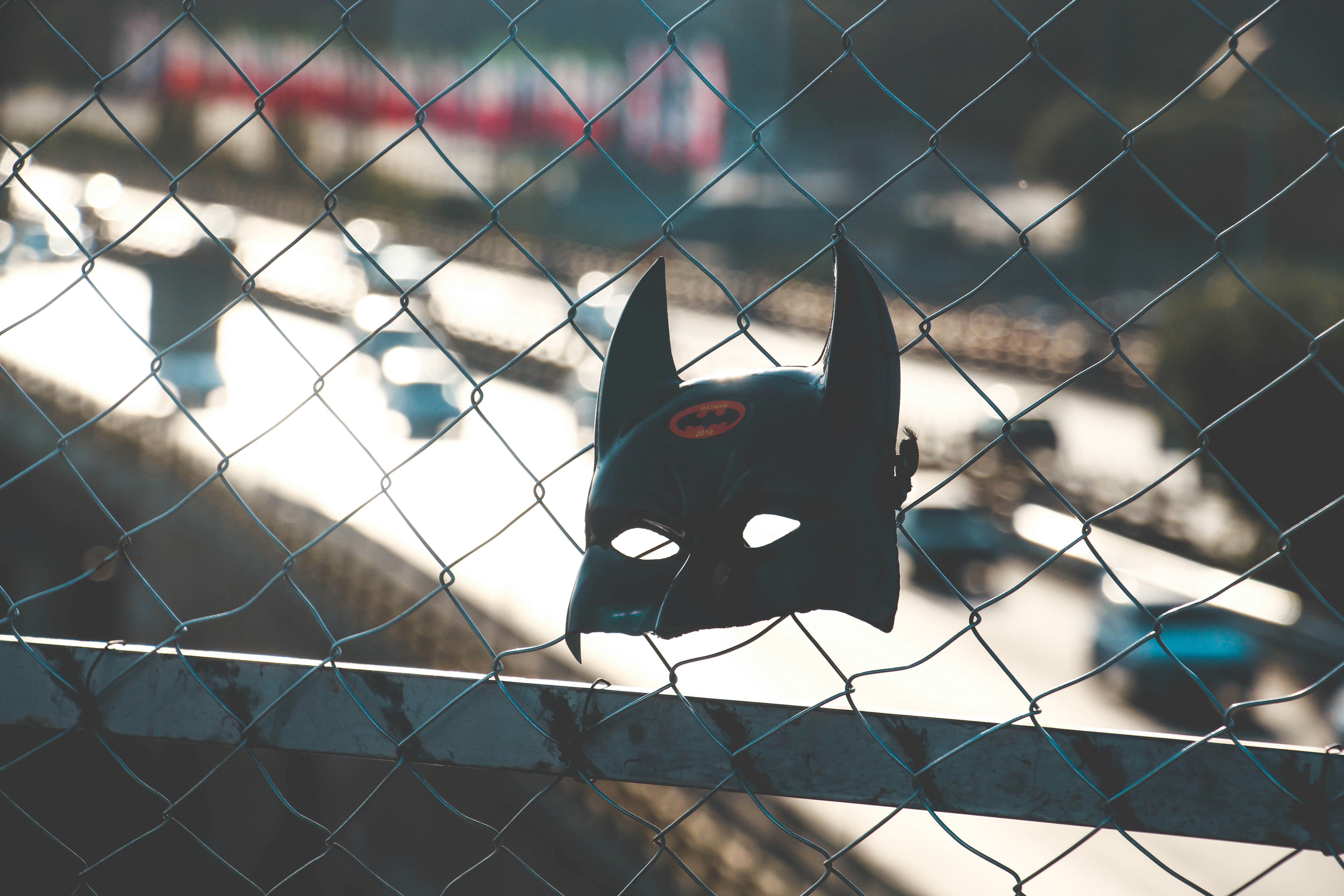 A batman mask on a fence near a highway photo – Free Tehran Image on ...