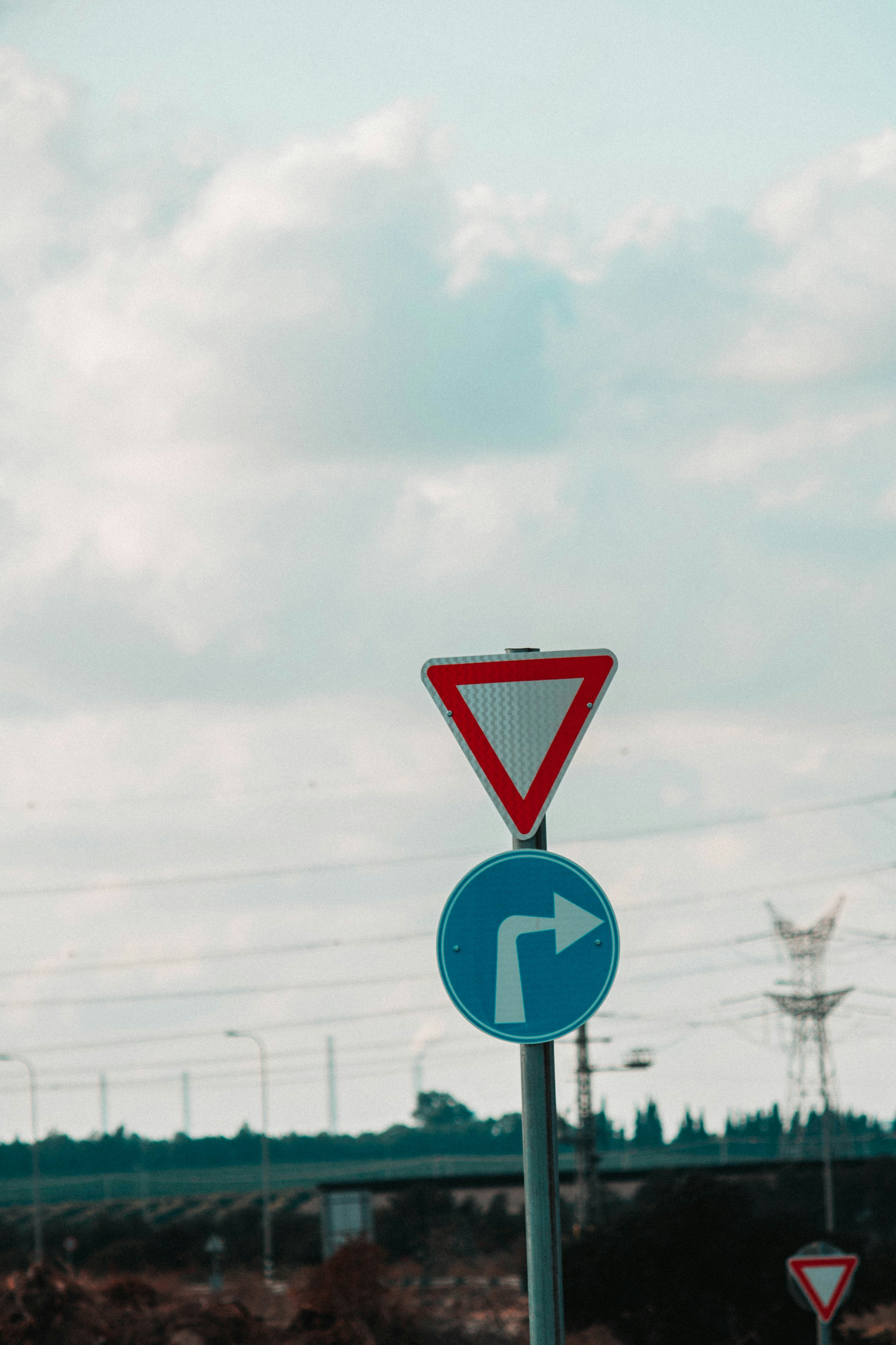 a couple of street signs sitting on the side of a road