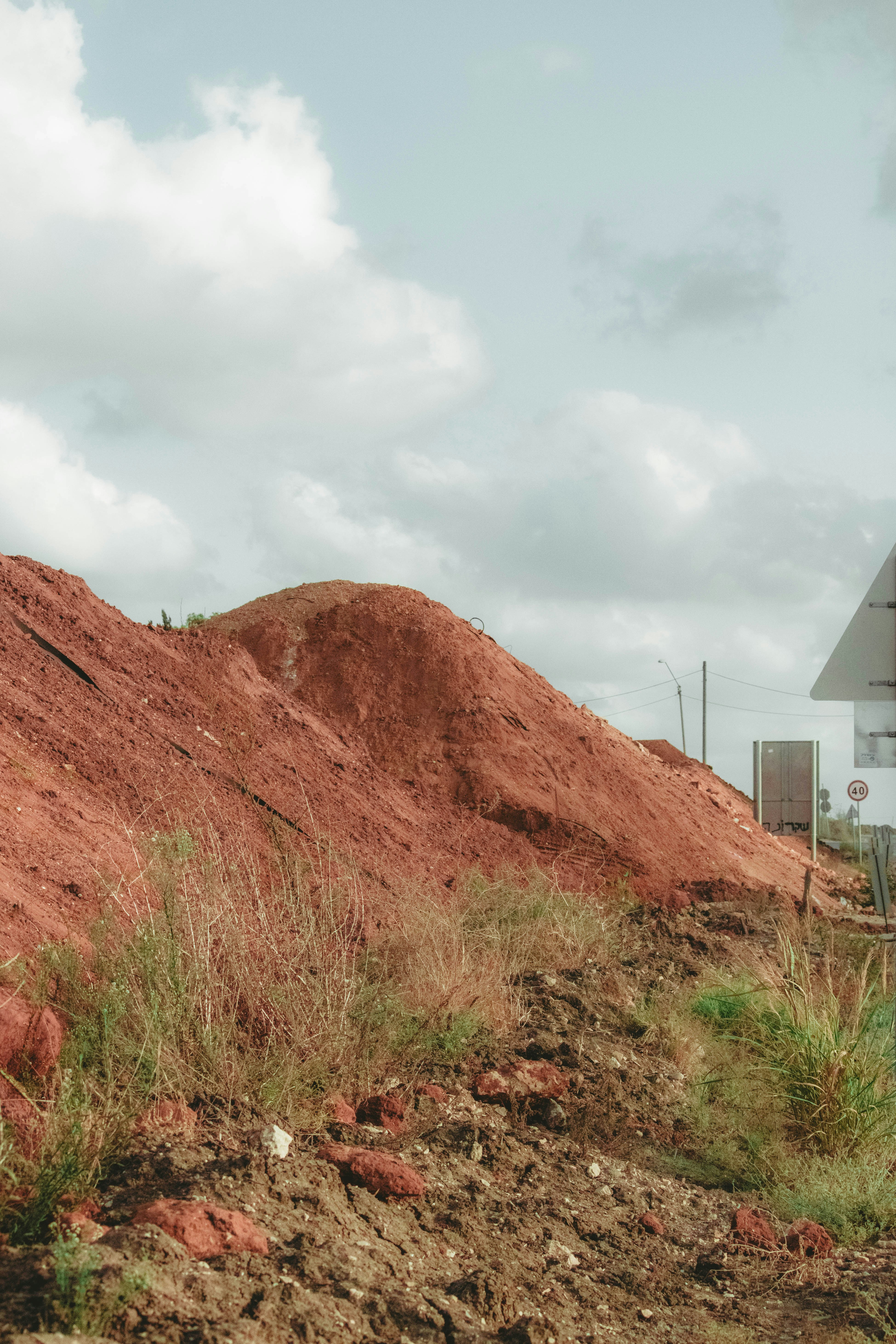 Un tas de terre rouge à côté d’un bâtiment photo – Photo Neigung ...
