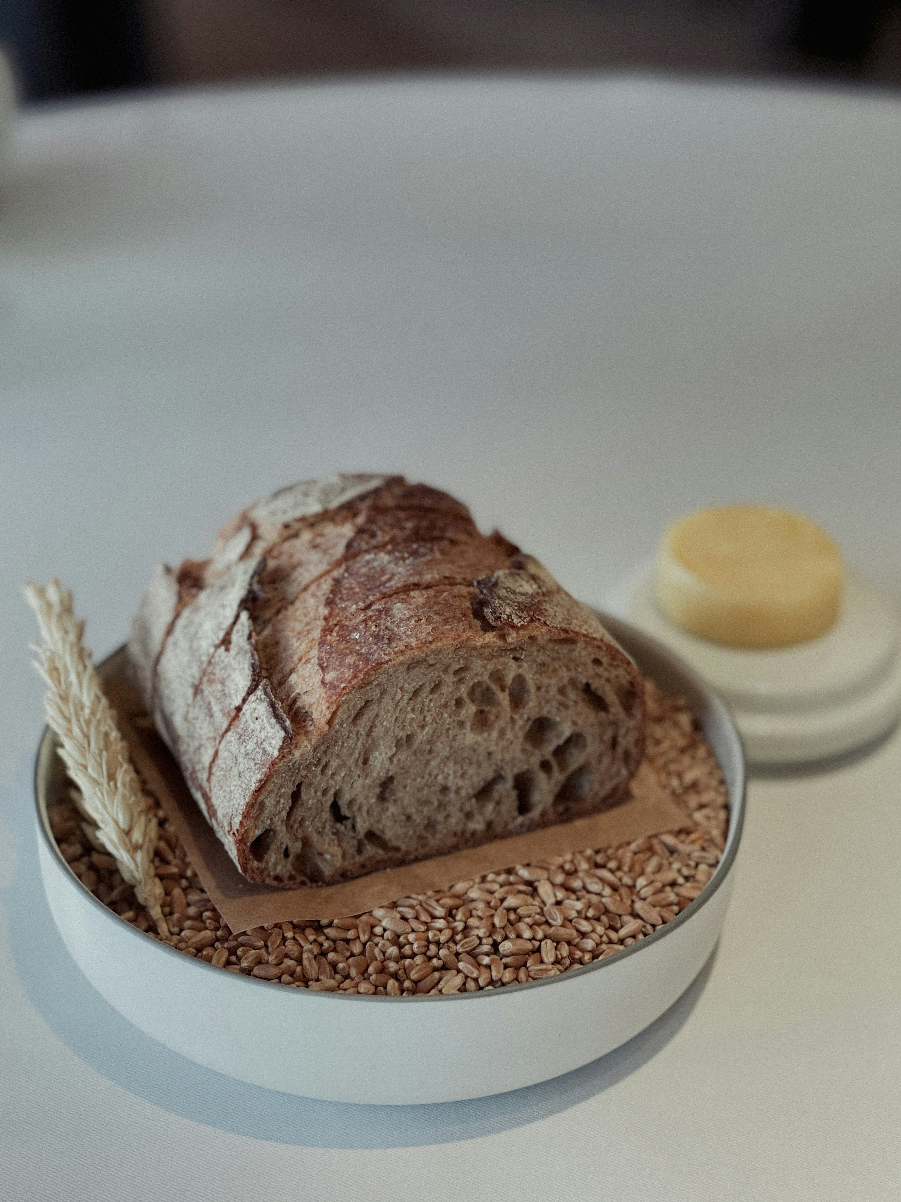 Crust on Seeded Plate: A Quiet Still-Life of Bread and Butter