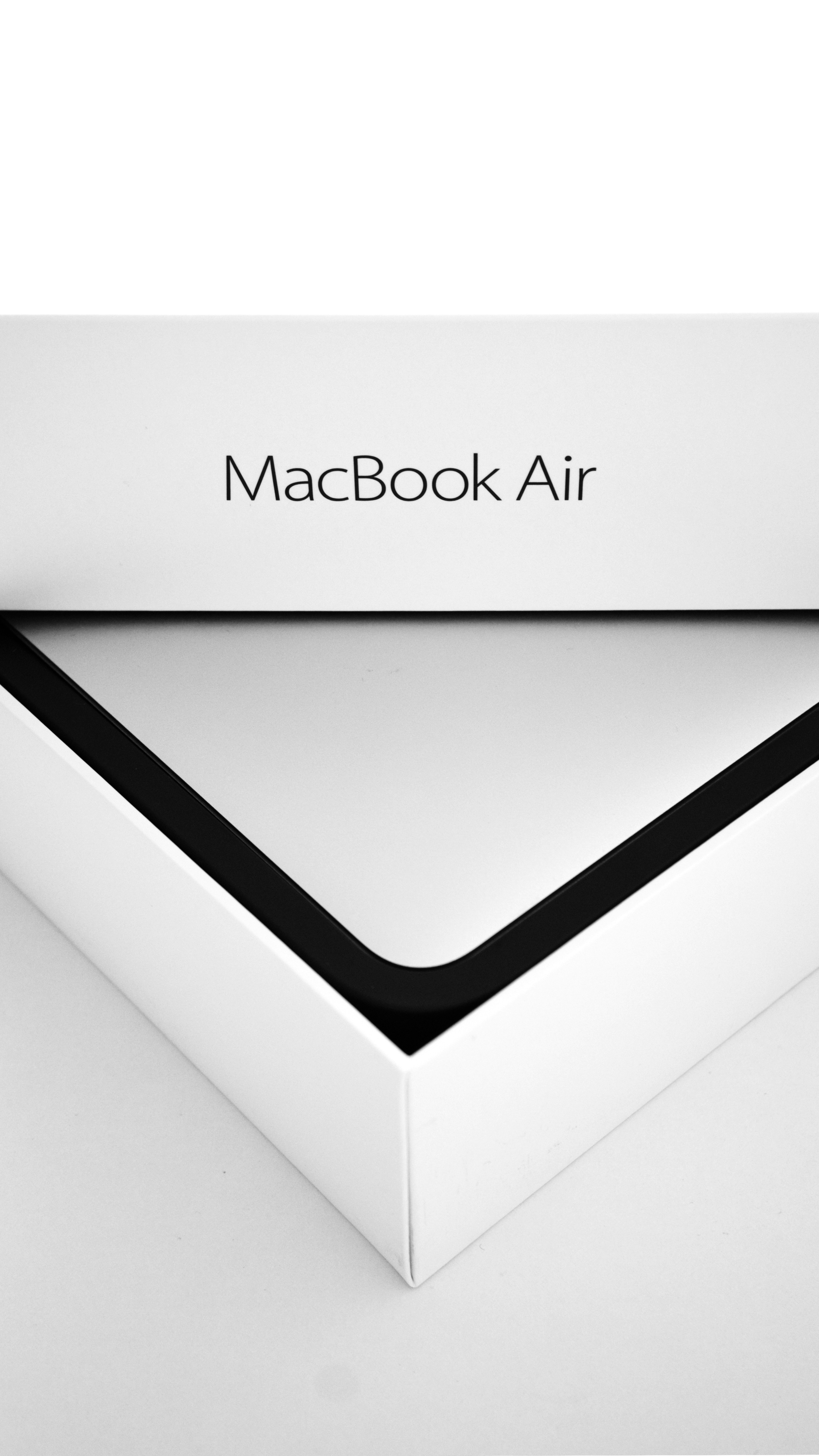 A macbook air box sitting on top of a table photo – Free Charge Image ...