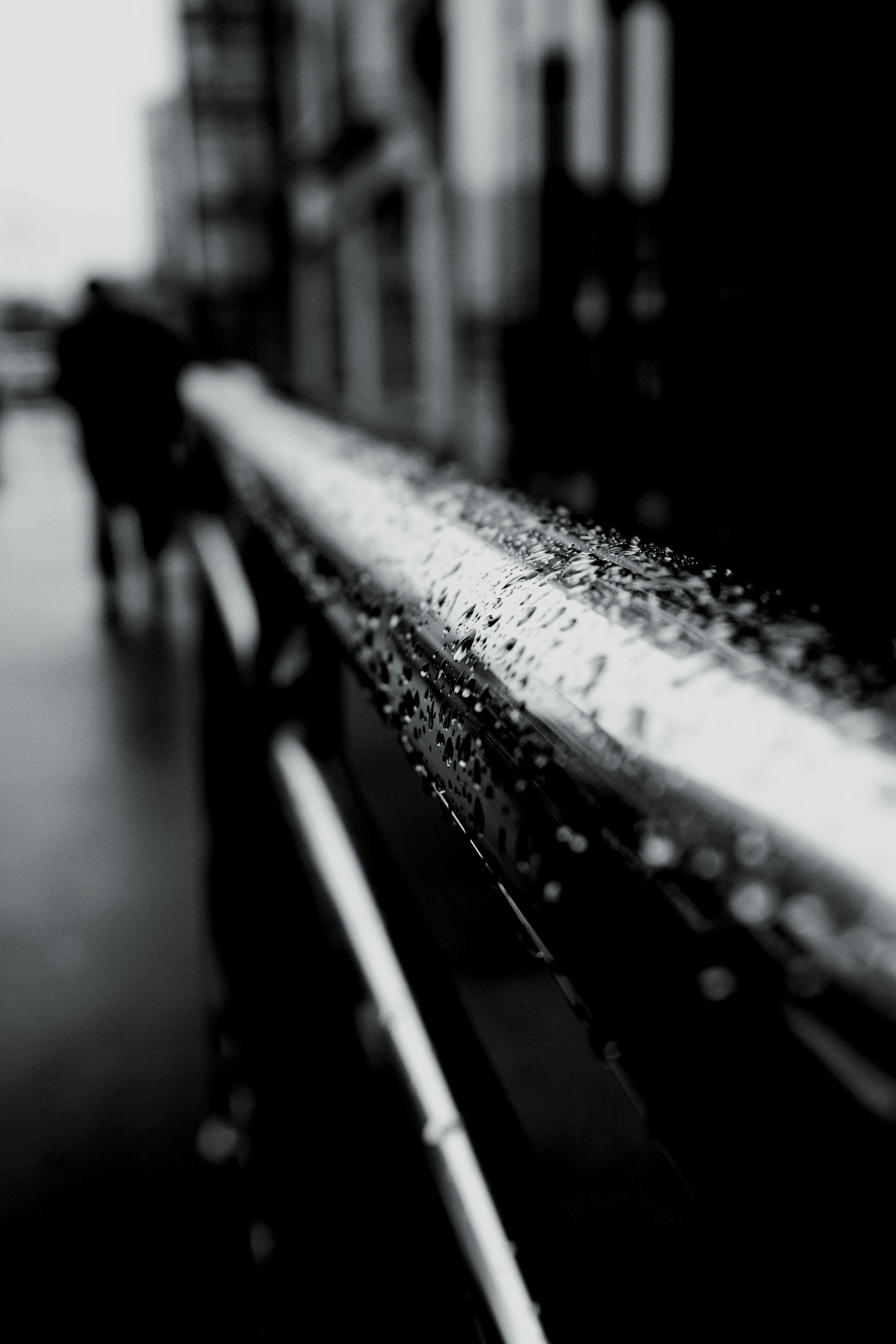 a black and white photo of people walking down a street