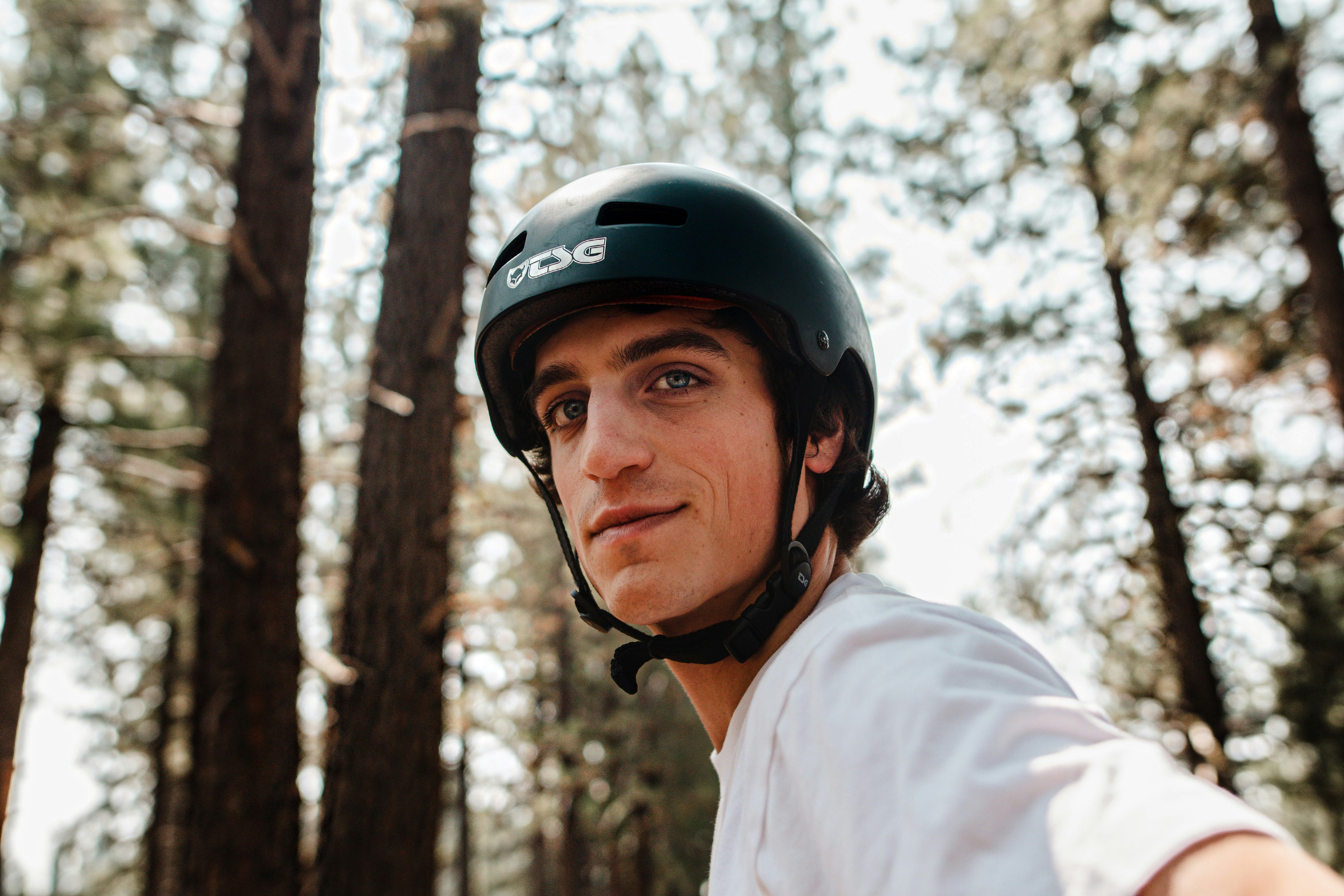 a man riding a bike through a forest