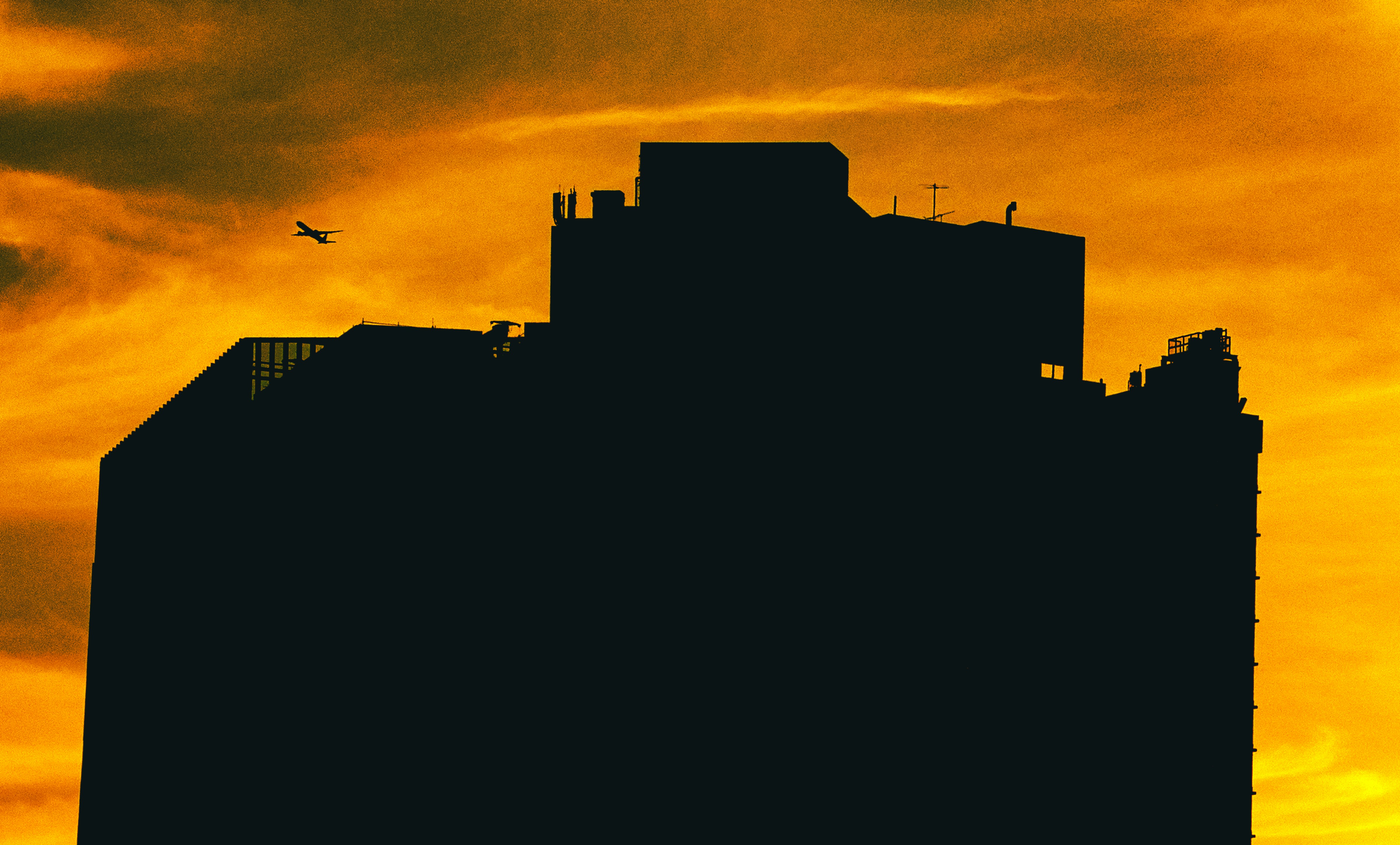 Silhouette at Dusk: Urban Gasp of a Roofline