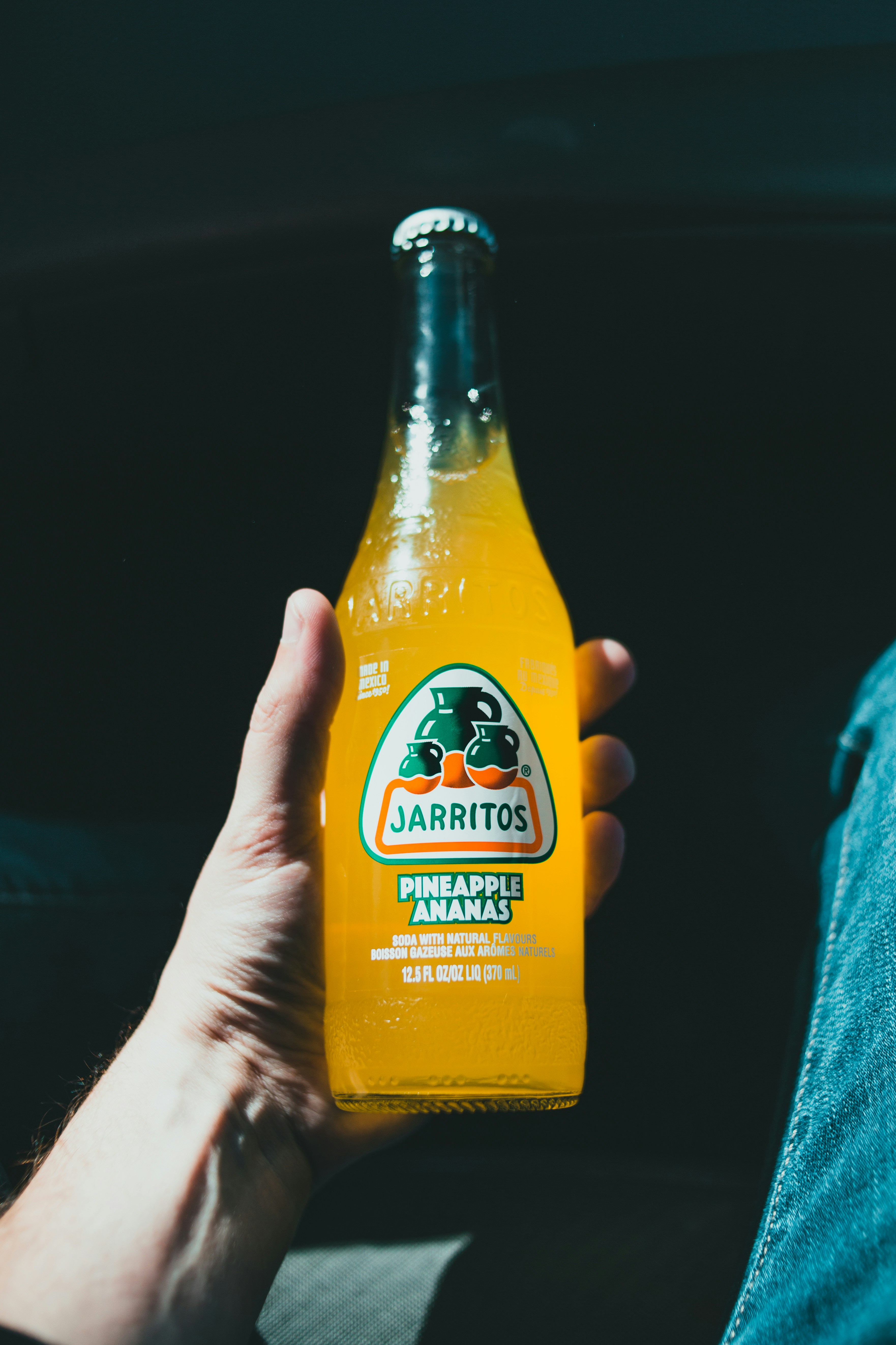 a person holding a bottle of orange juice