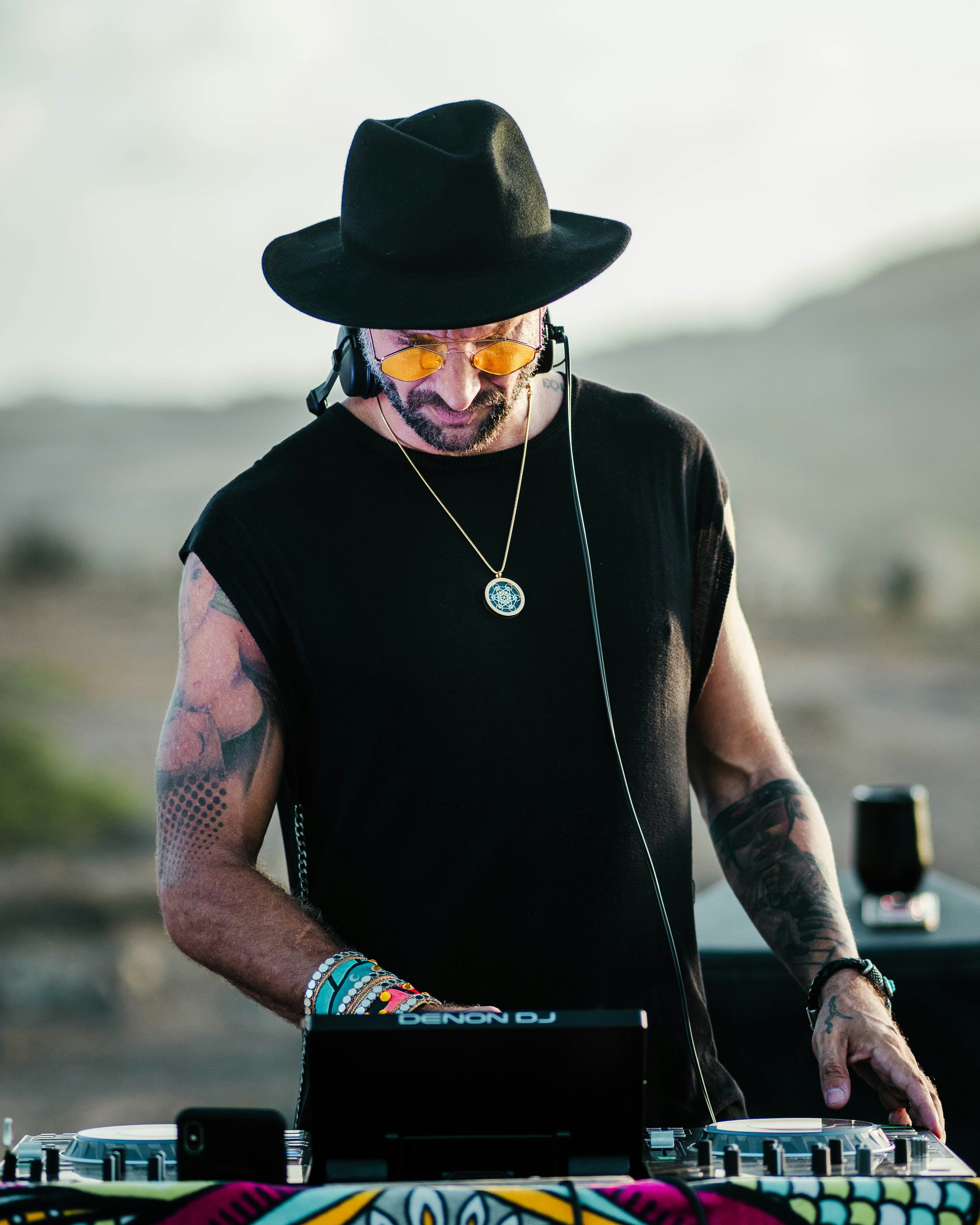 A man in a black hat is playing a dj set photo – Free Aruba Image on ...