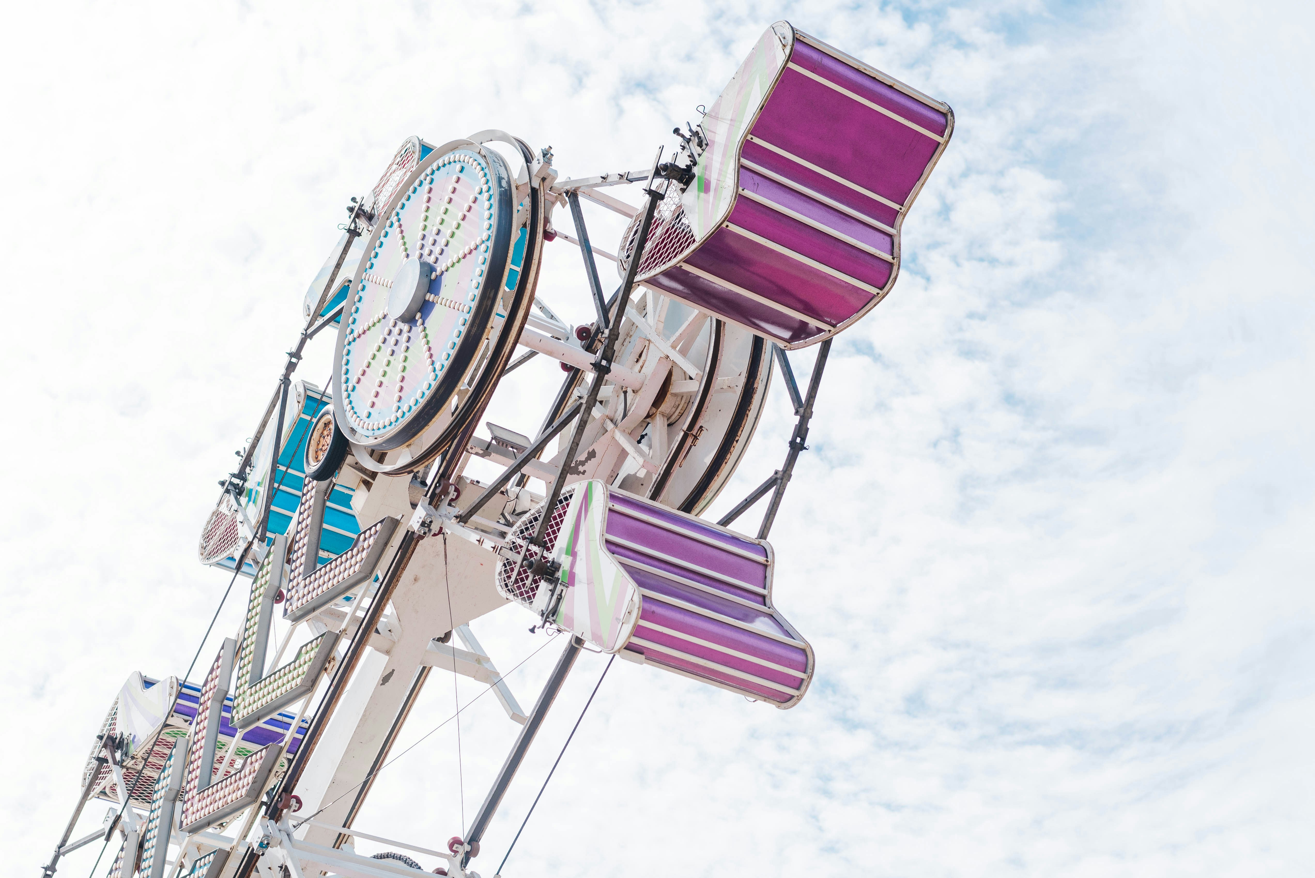 Tilted Ferris Wheel Against a Powder-Blue Sky