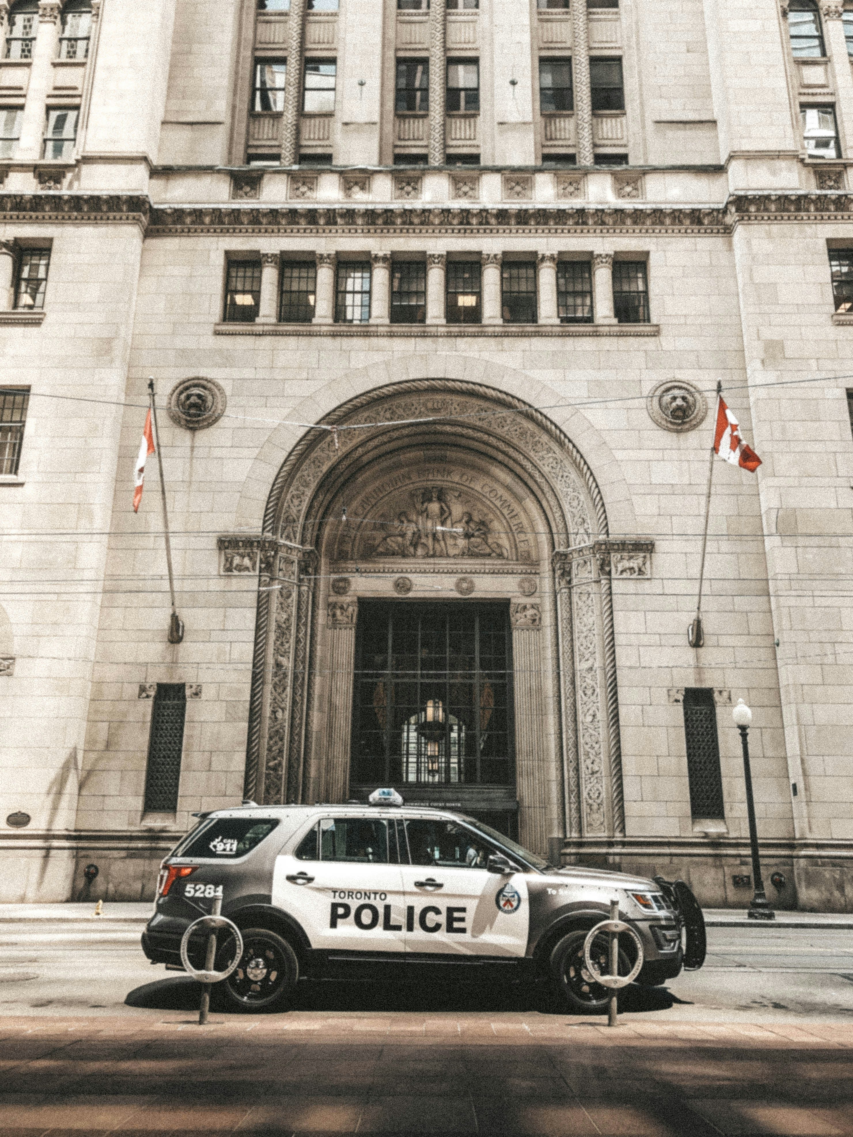 Patrol at the Keystone: A Toronto Police SUV Framed by a Monumental Facade