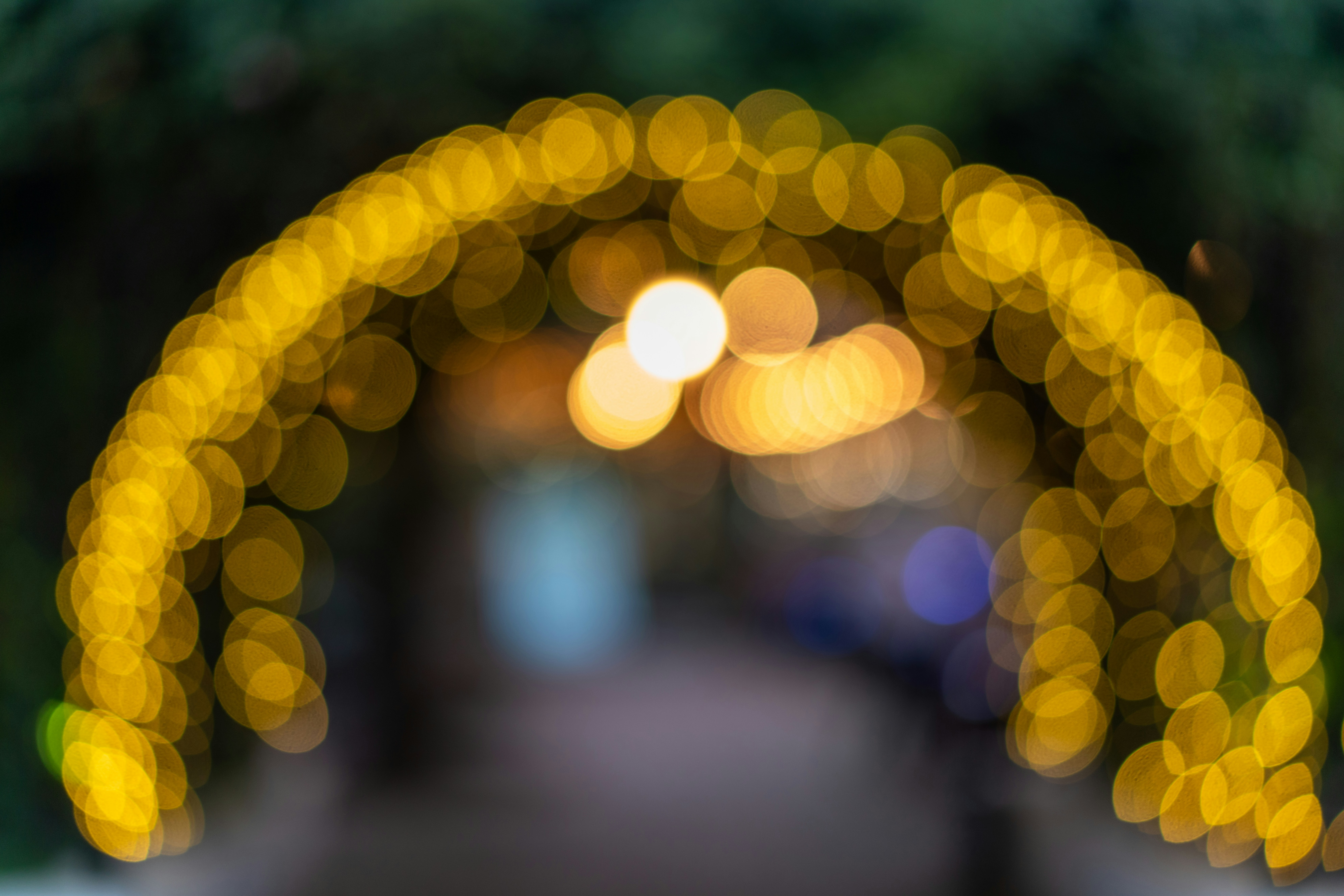 Golden Archway of Bokeh Lights Over a Dim Alley