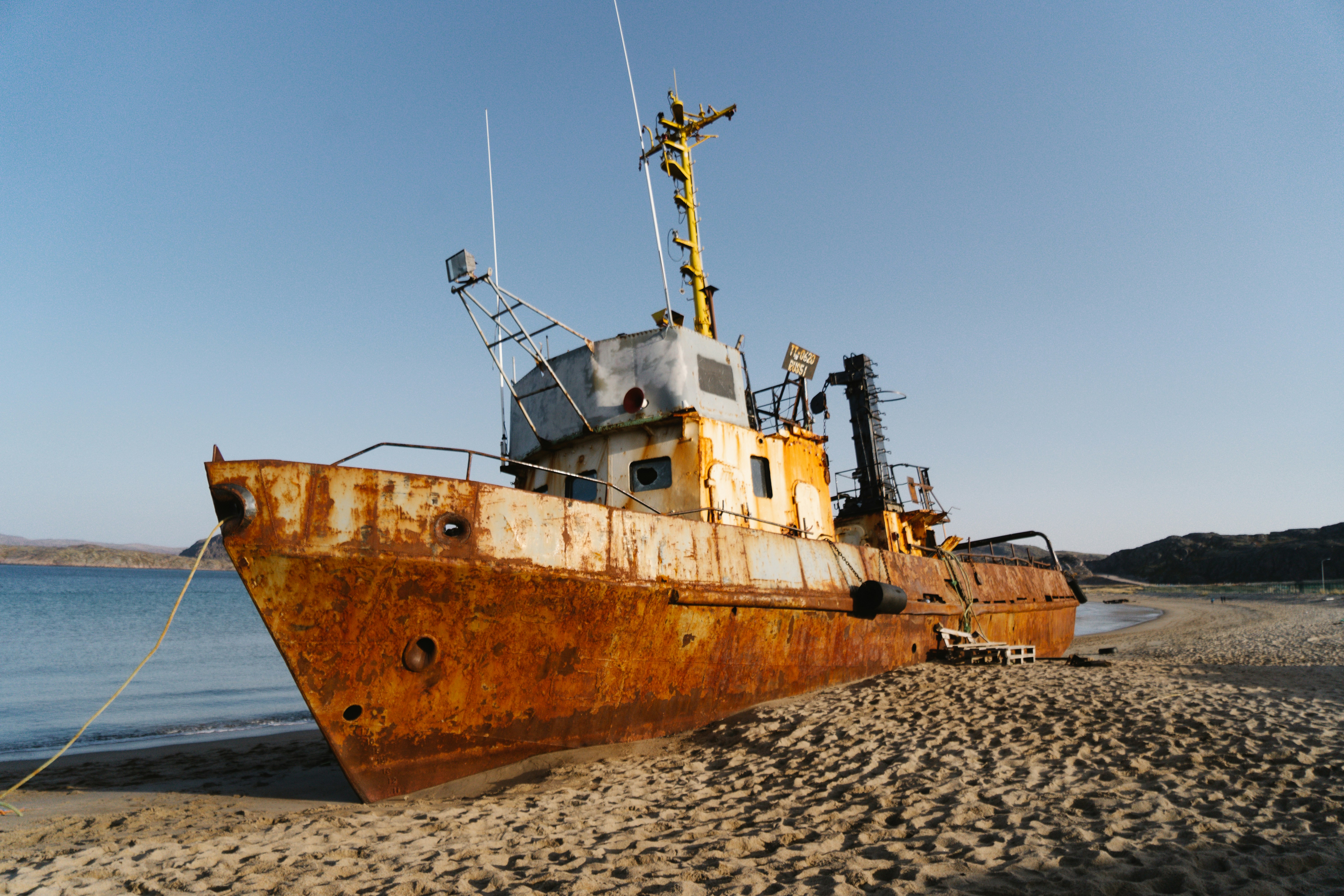 A rusted boat sitting on top of a sandy beach photo – Free Teriberka ...