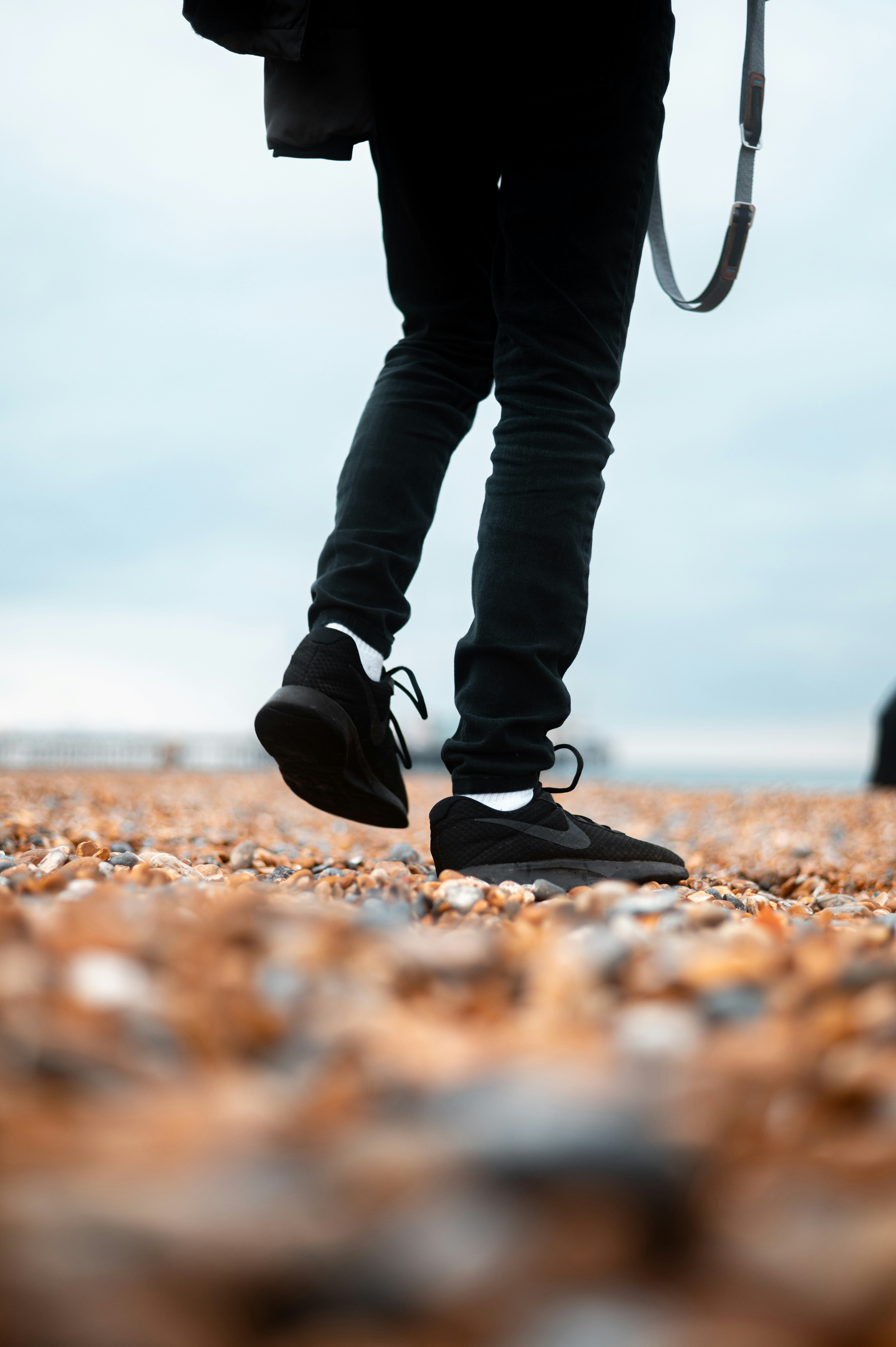 Low-Angle Stride on a Pebble Beach Shore