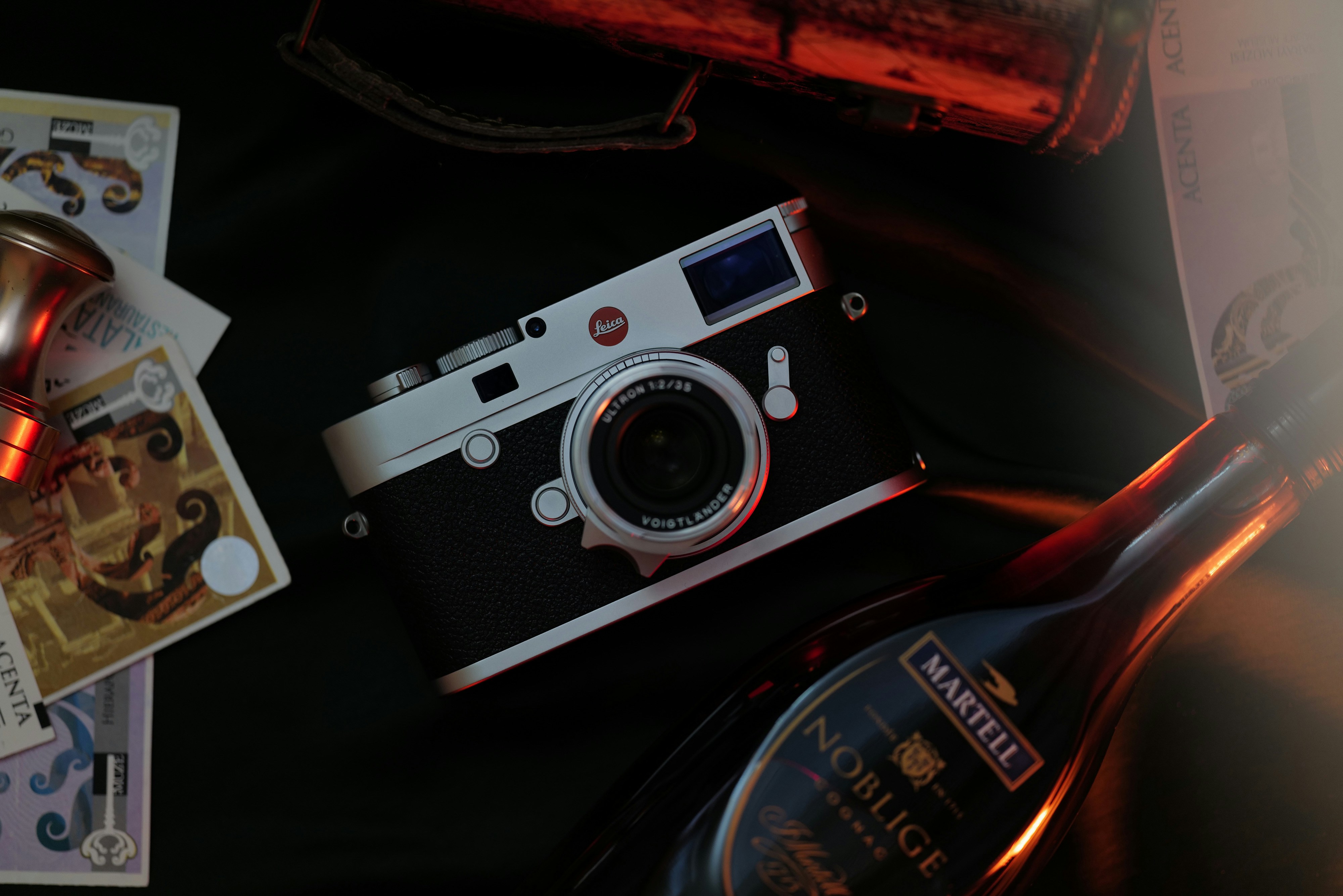 Leica SL2 Noir: A Quiet Still Life with Cards, Currency, and a Bottle