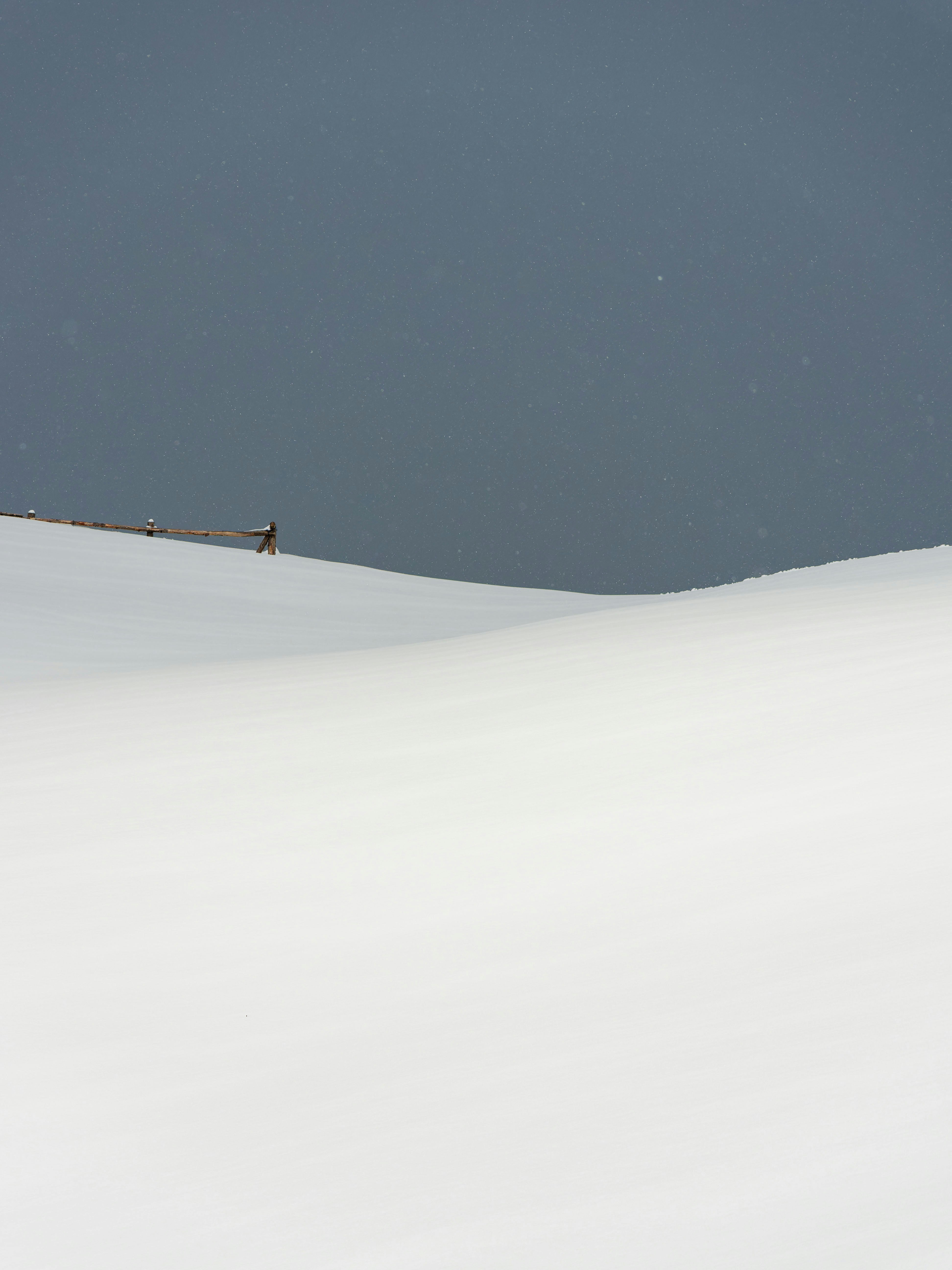 Two Figures on a Snow Ridge Beneath a Deep Winter Sky