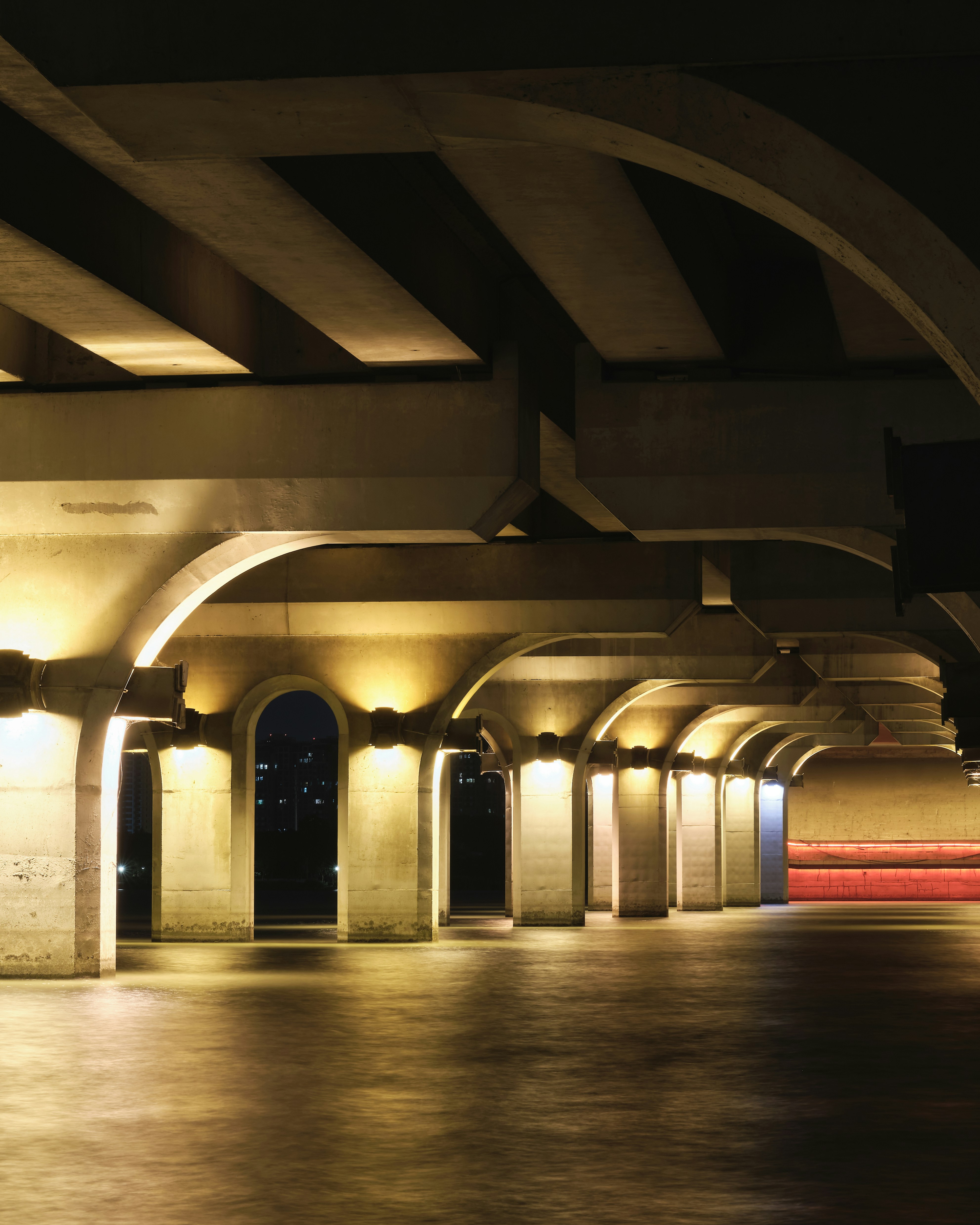 Under the Arch: Evening Light in a Modern Concrete Corridor