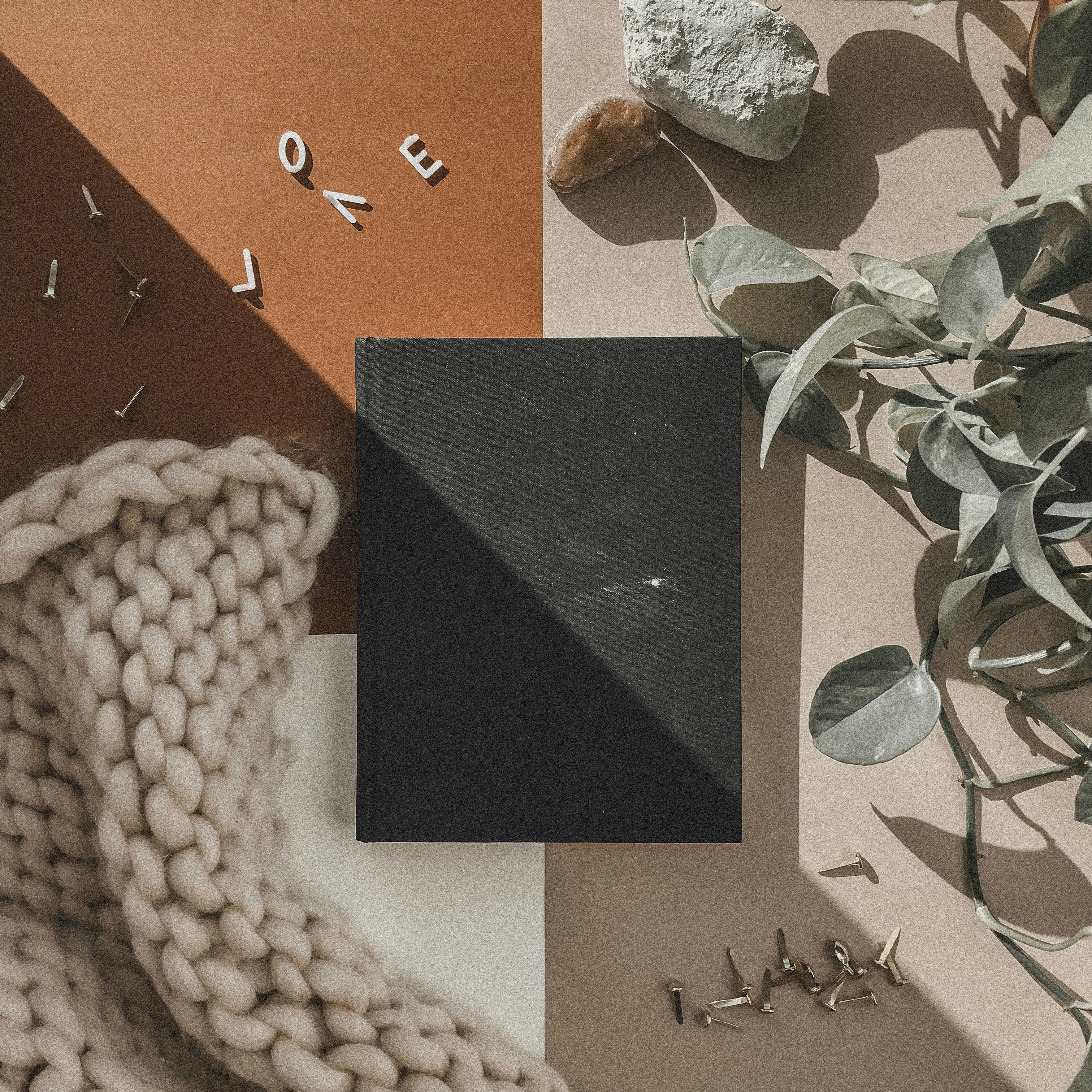 Heart of Contrast: A Central Matte Tile Surrounded by Knit, Leaves, and Earthy Tones