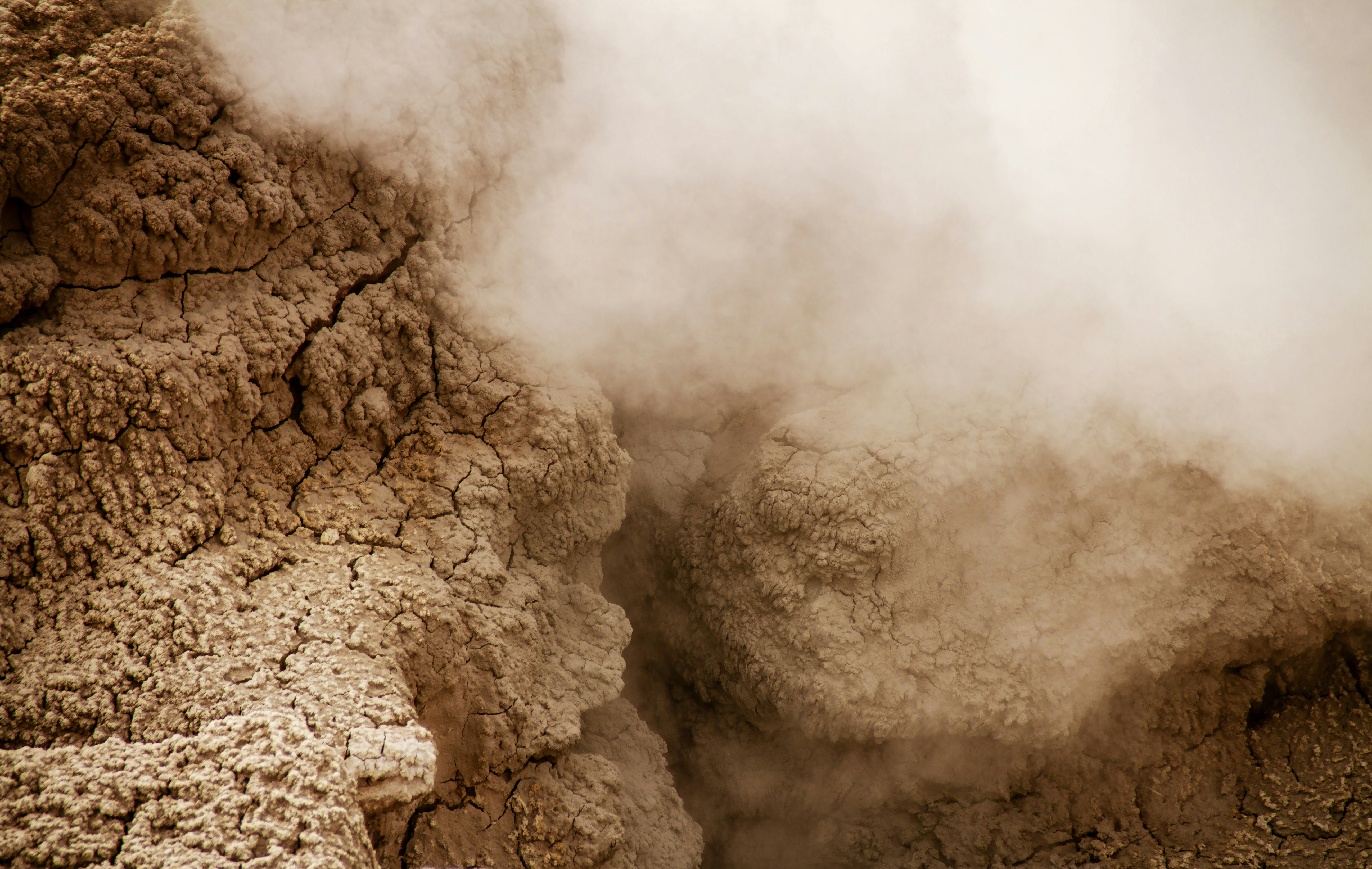 Cracked Terra Vent: Steam Rises Through a Sepia-Toned Ridge