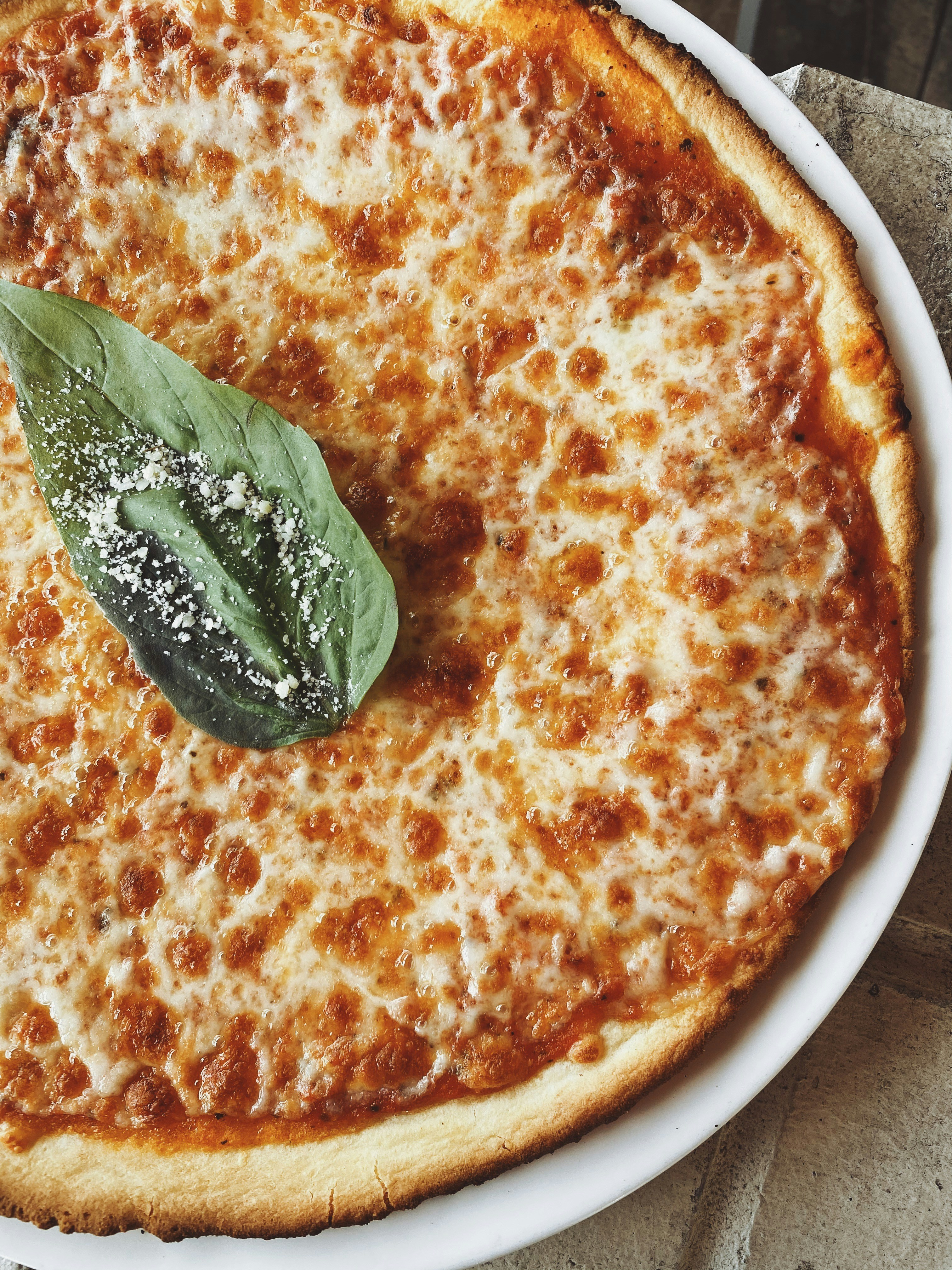A pizza with a leaf on top of it photo – Free Pizza Image on Unsplash