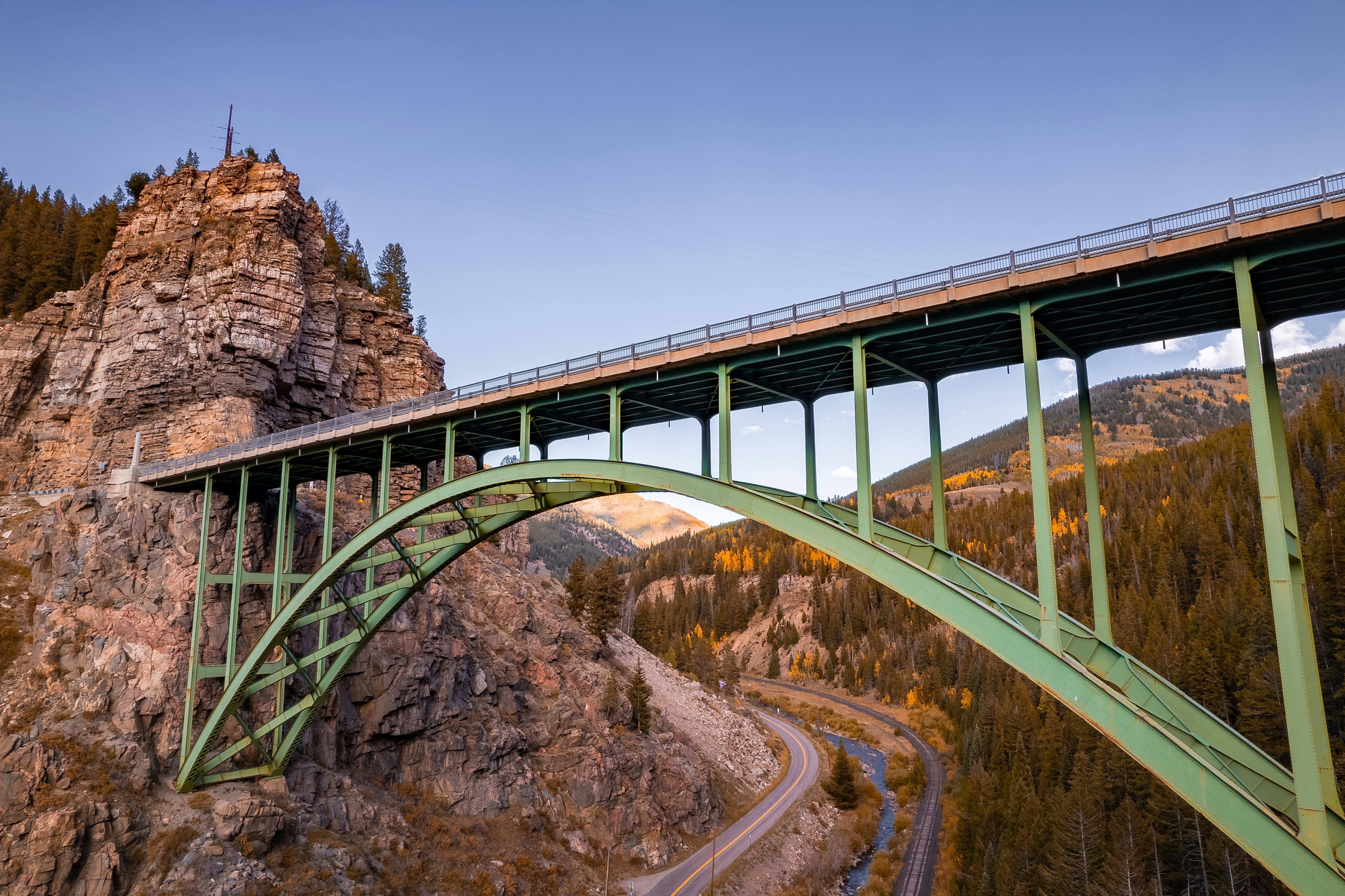 A bridge over a mountain with a road going under it photo – Free Co ...