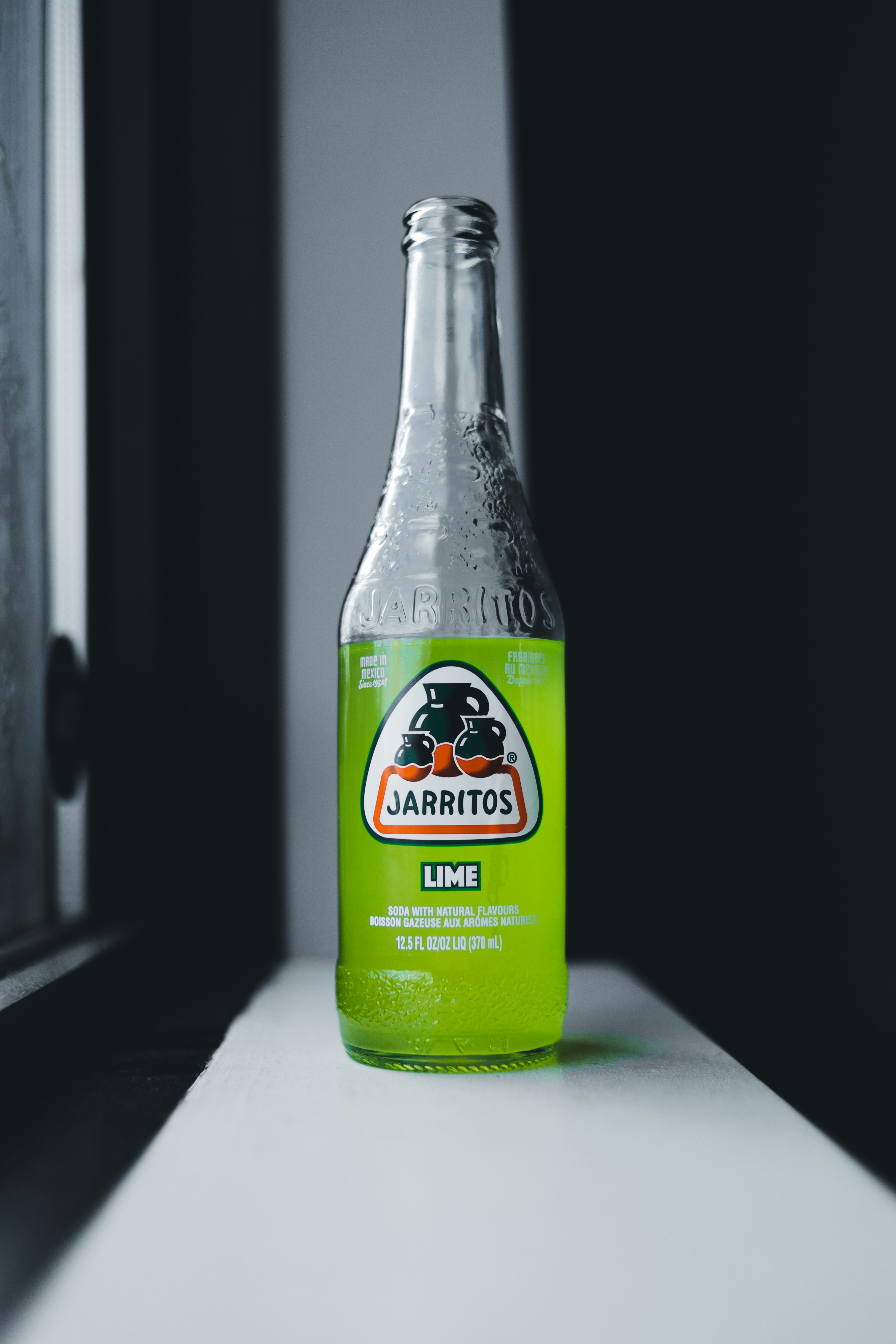 a bottle of beer sitting on a window sill