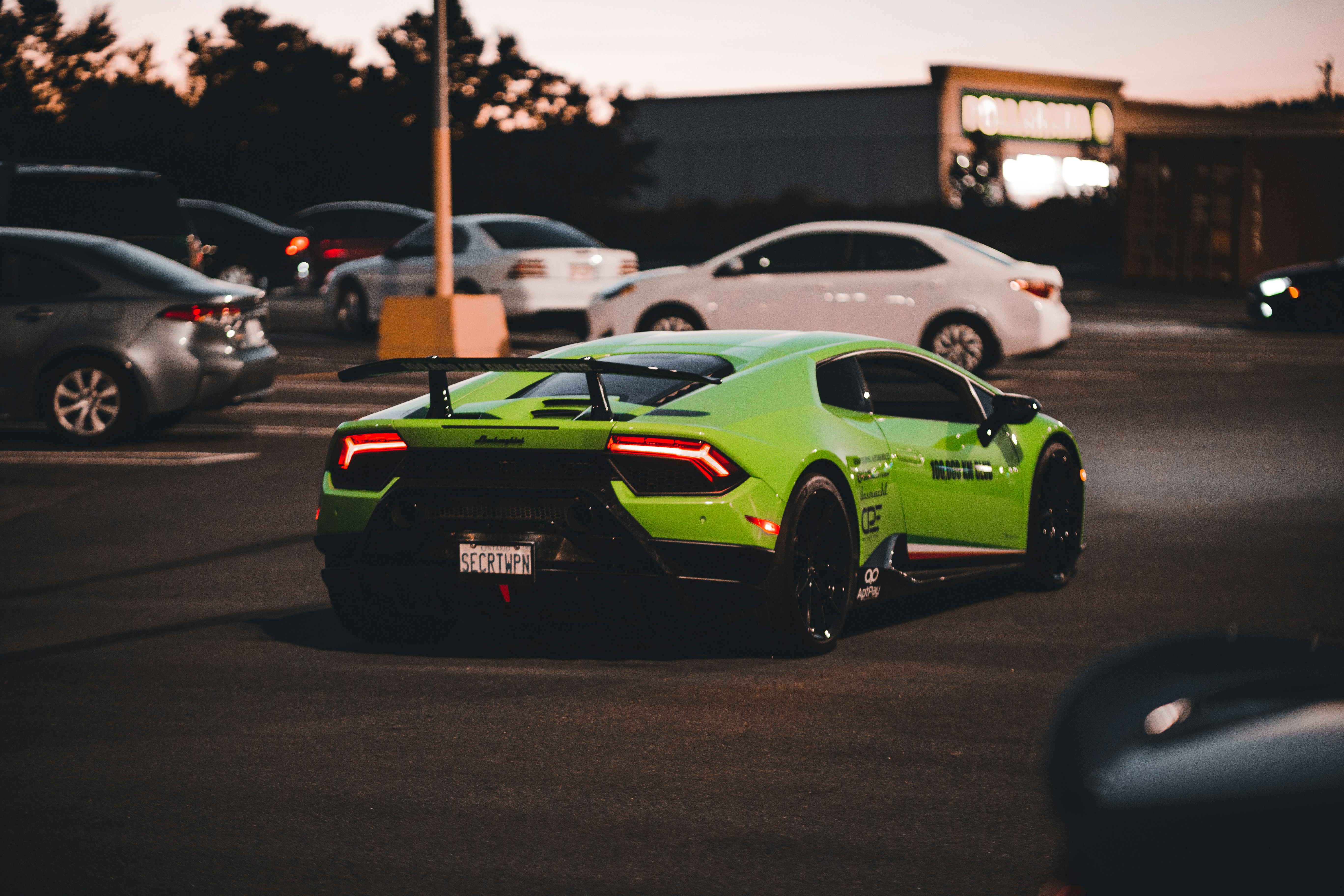 a green sports car parked in a parking lot