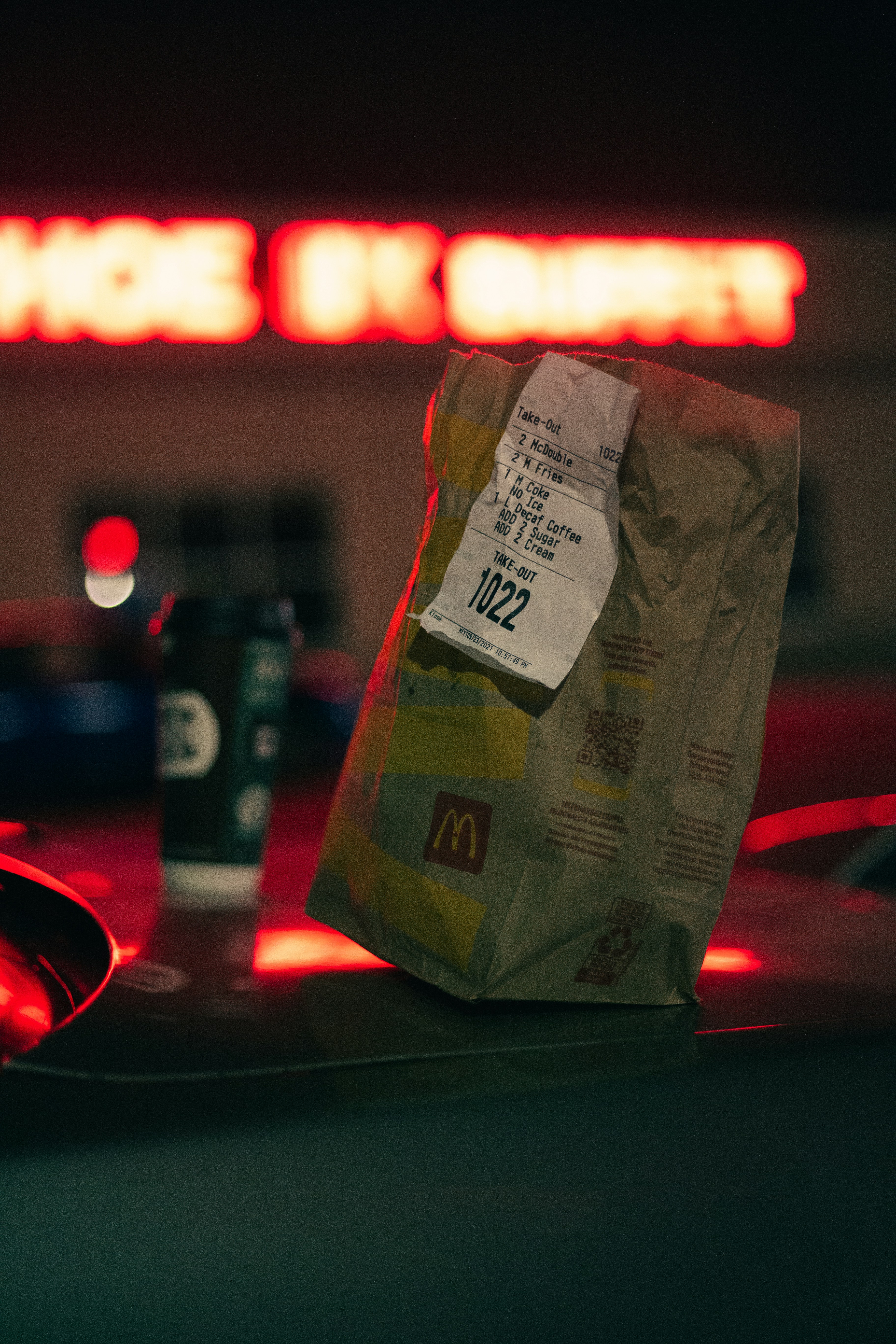 Midnight Takeout: Crumpled Bag Under Neon Red