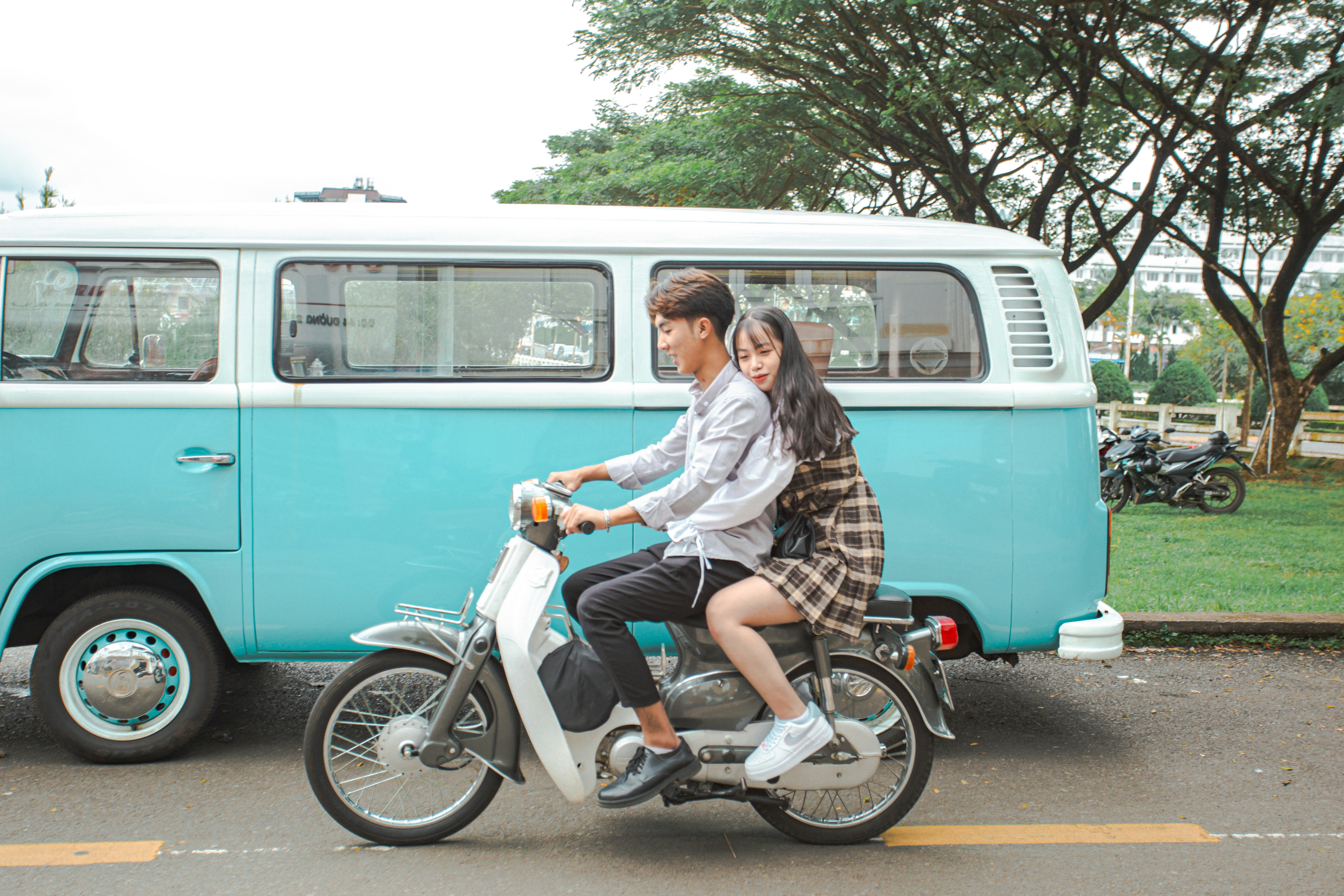 Vivid Ride: A couple on a retro teal van-lined street escape