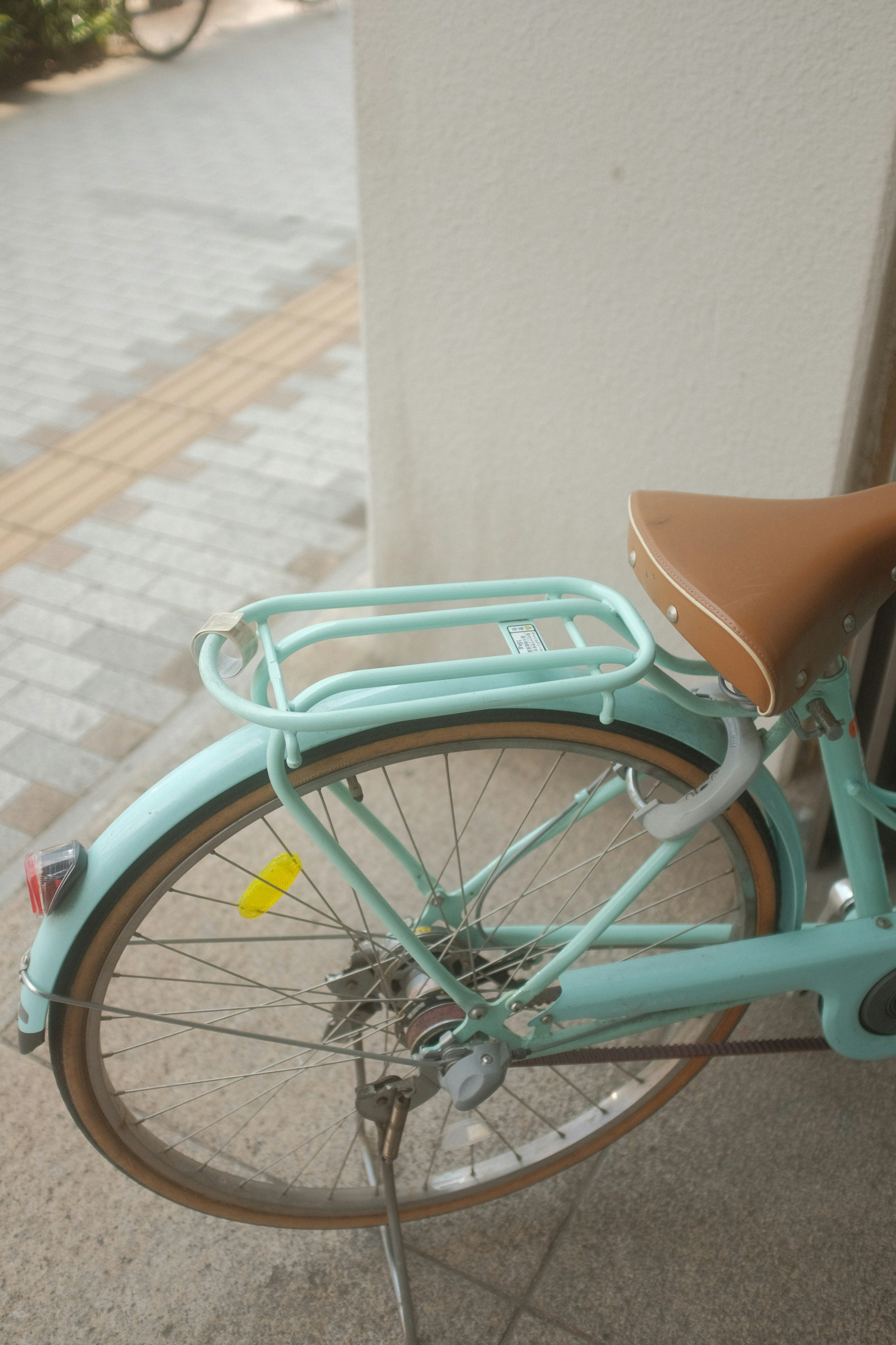 Pastel Cruiser: A Mint Bicycle Paused by a Quiet Wall