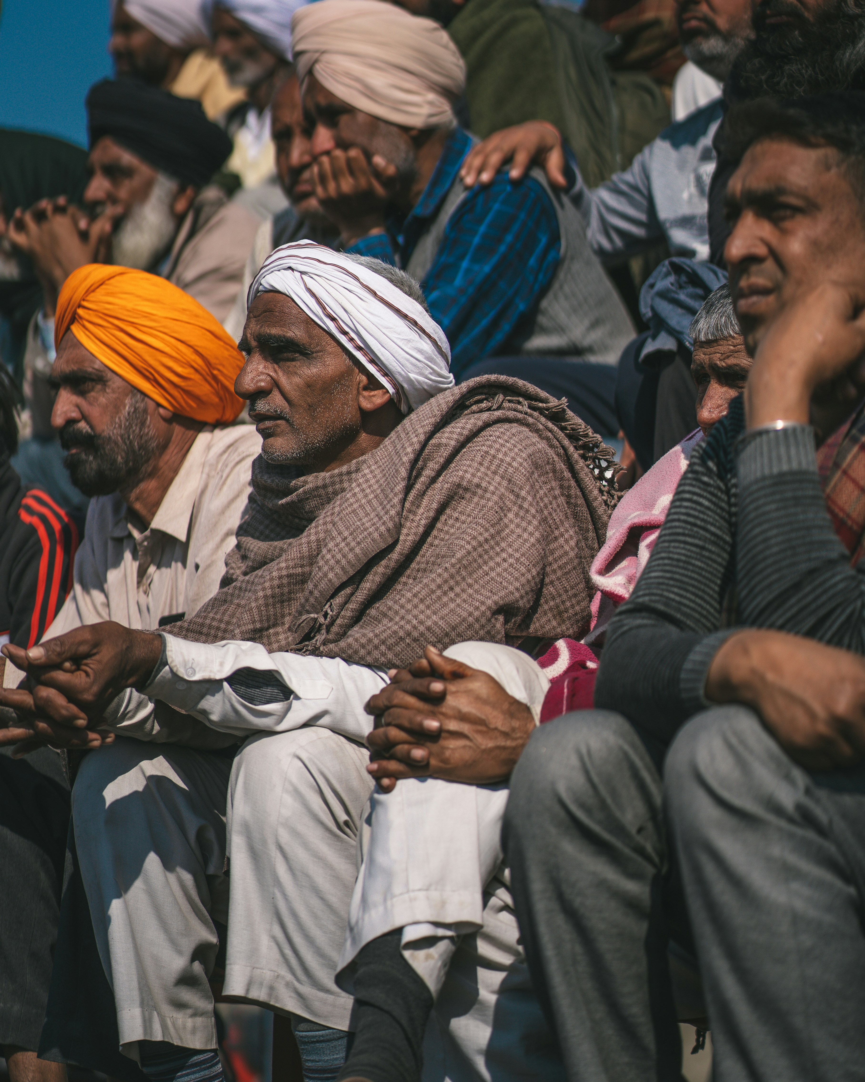 A group of people sitting next to each other photo – Free Human Image ...
