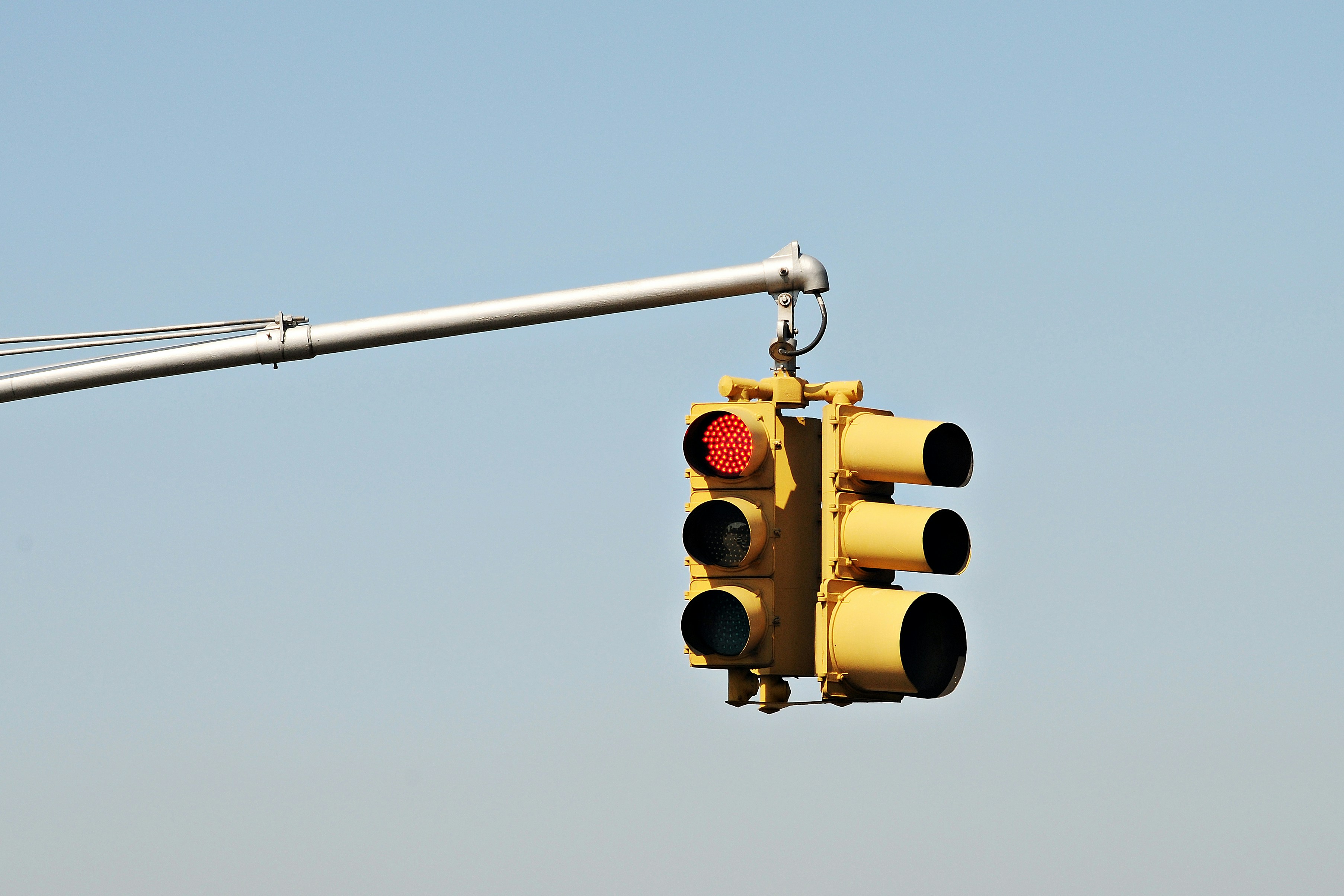A traffic light hanging from a metal pole photo – Free Traffic light ...