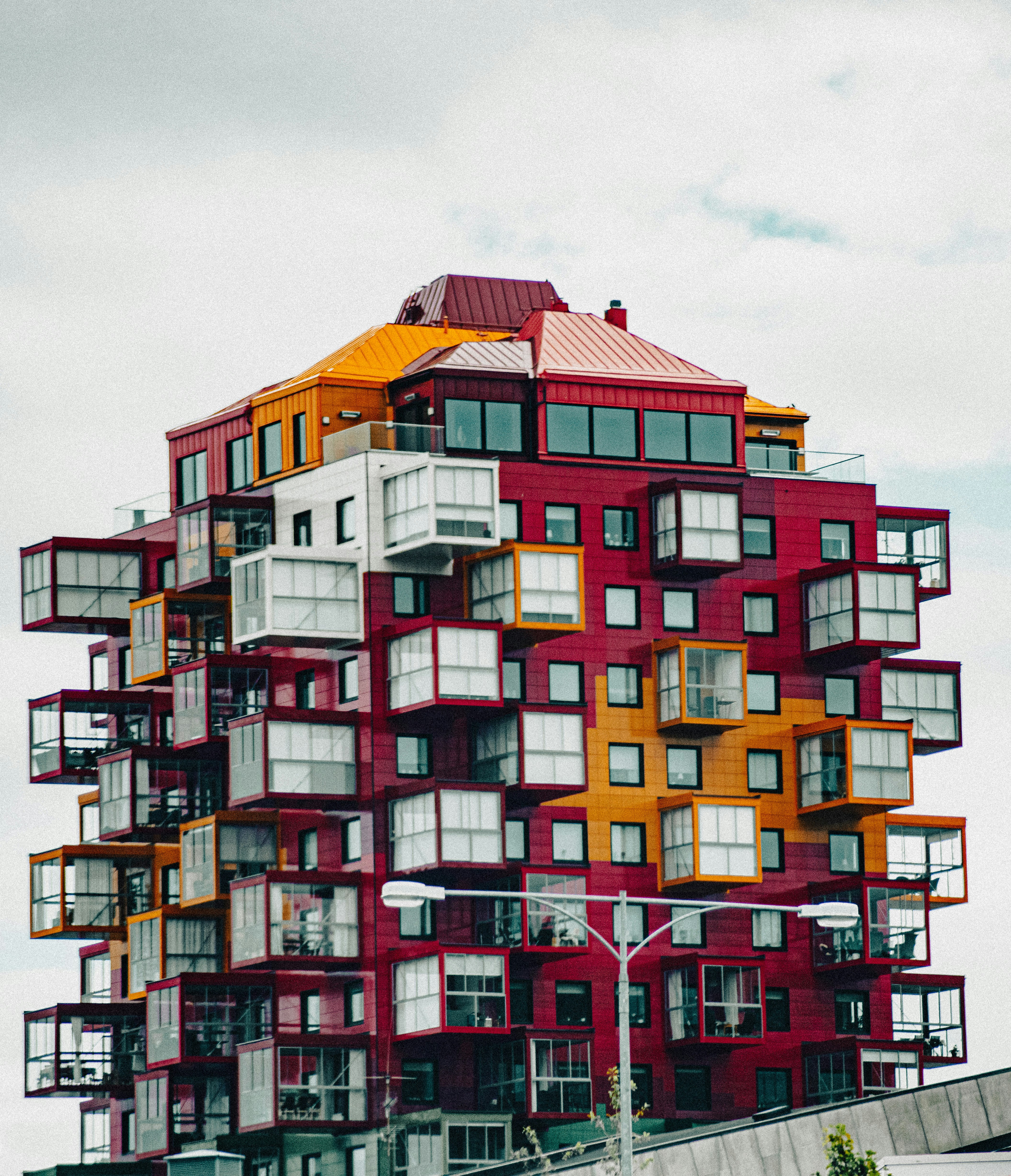 a tall red and yellow building with balconies