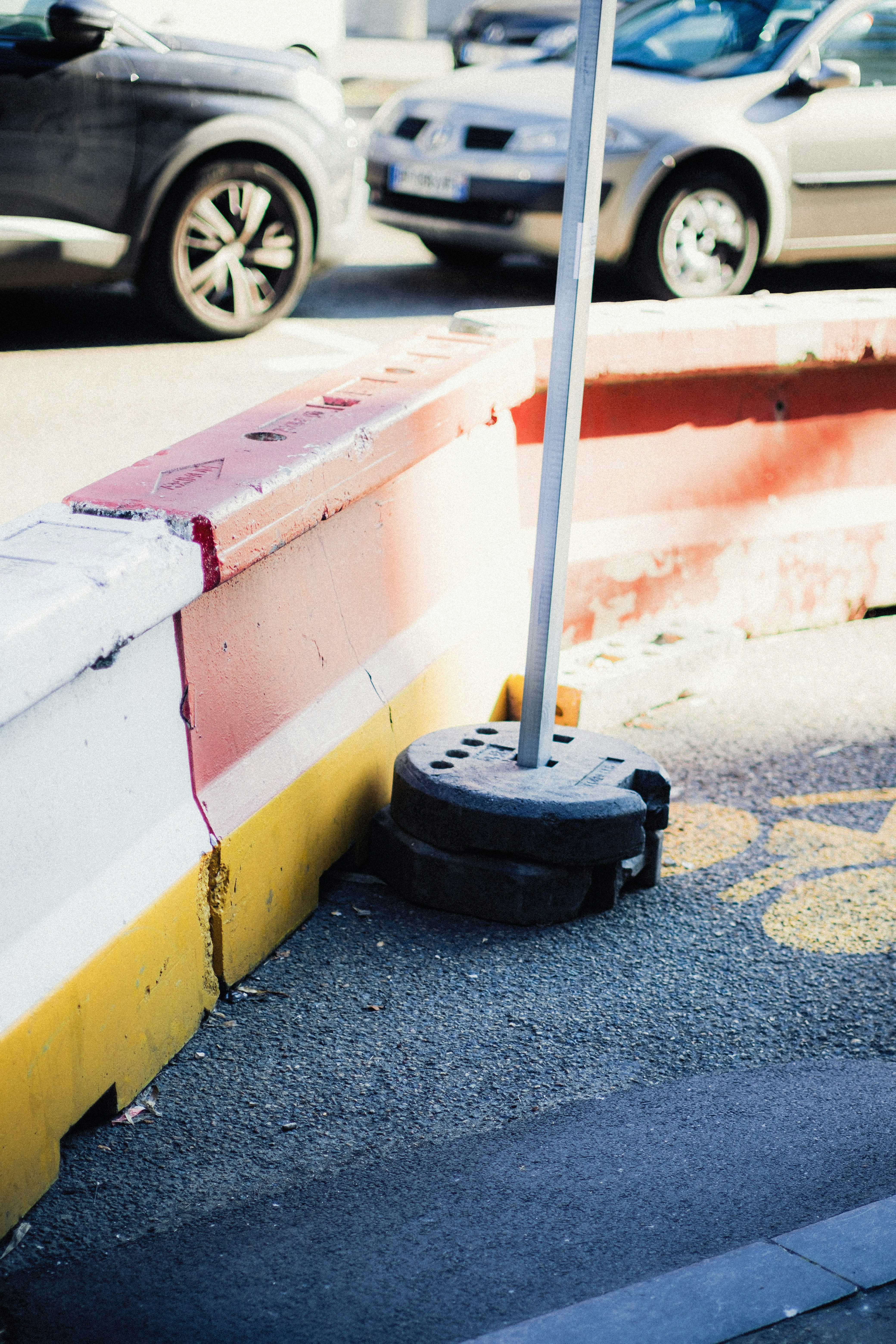 Street Barrier and Pole: Colorful Concrete Sepulchre of a Parking Lot