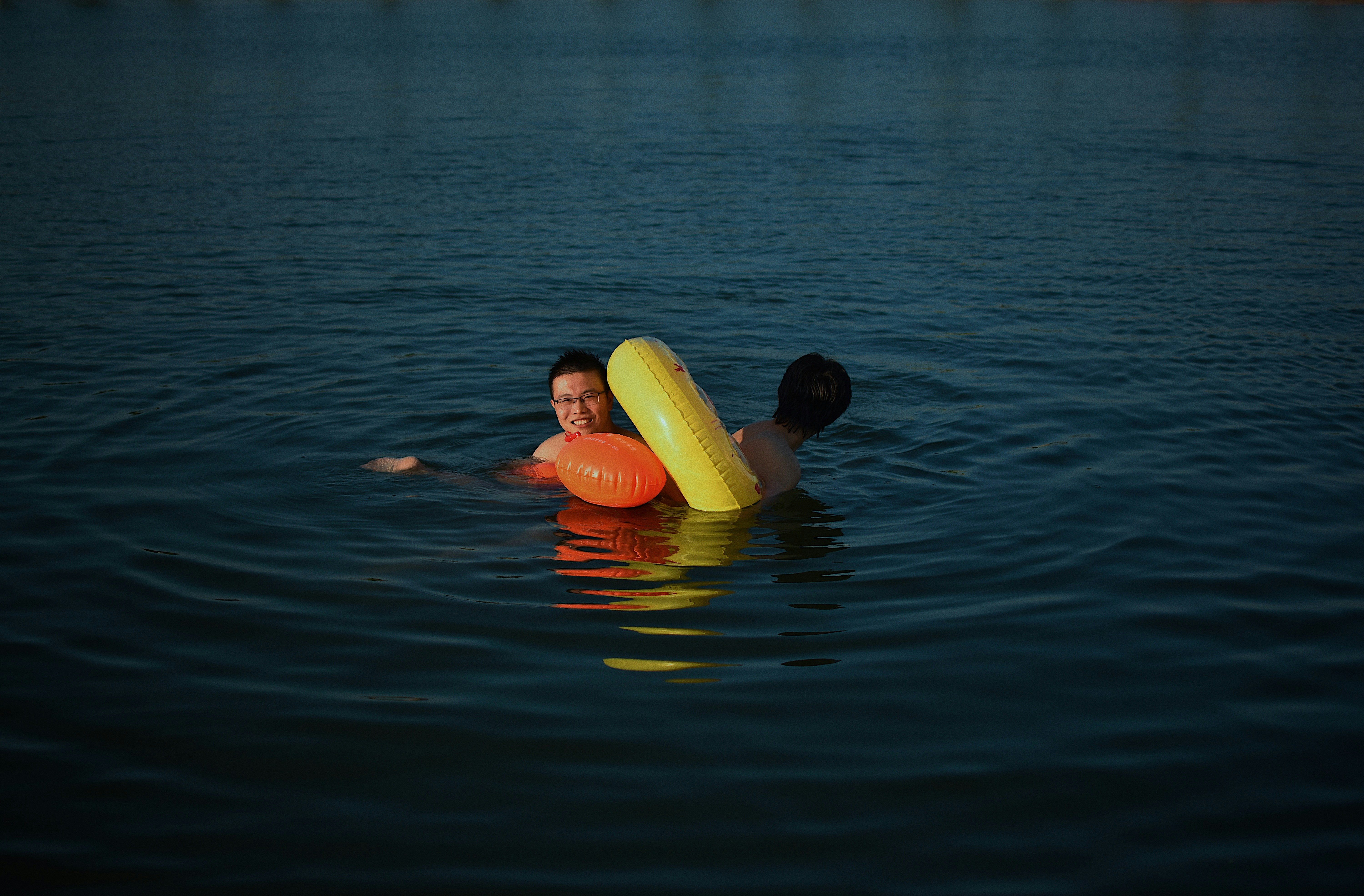 Two Faces, Two Rings: Dusk Swim on a Quiet Indigo Lake
