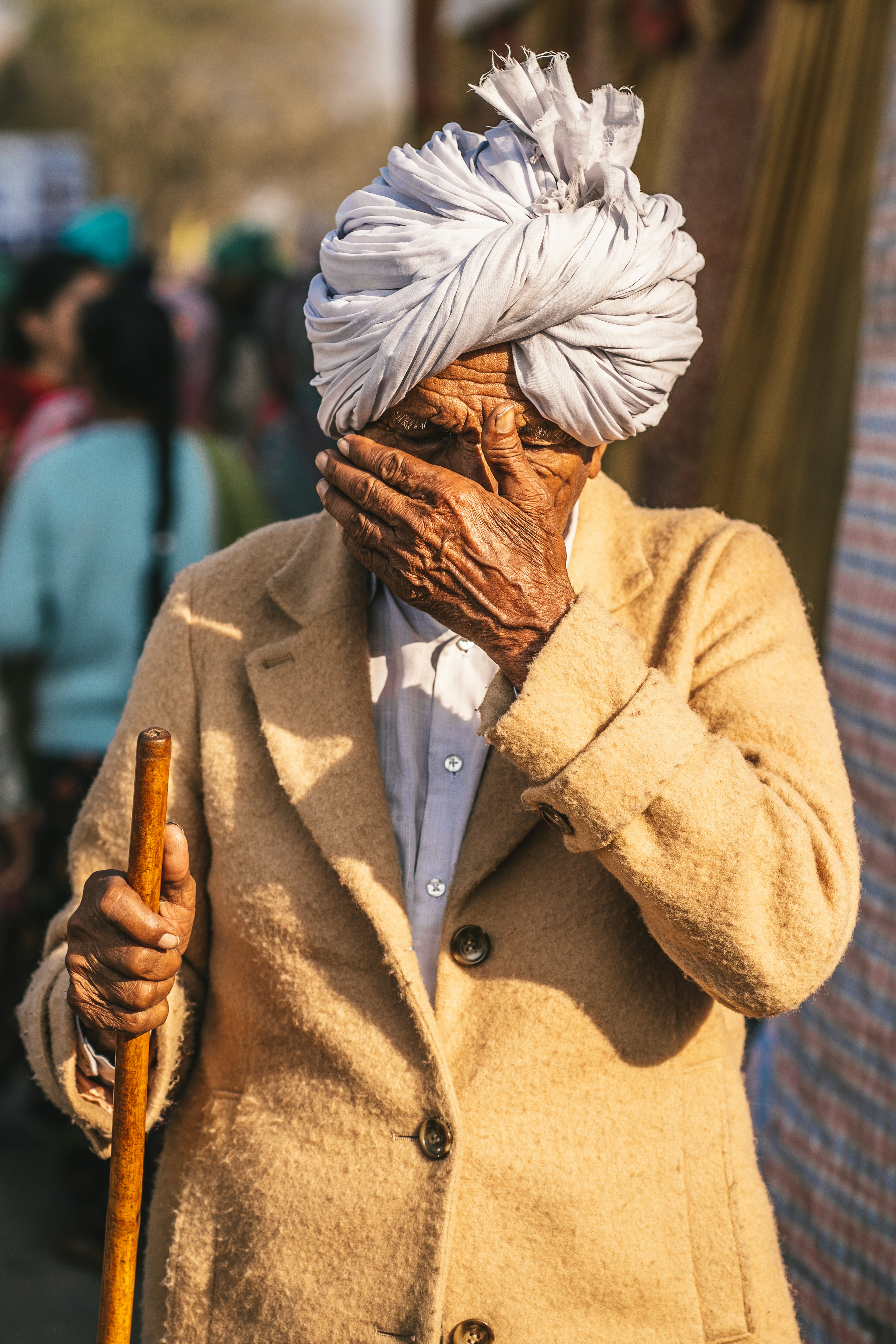 Hidden Hands and Warm Wool: A Turbaned Elder with a Wooden Cane