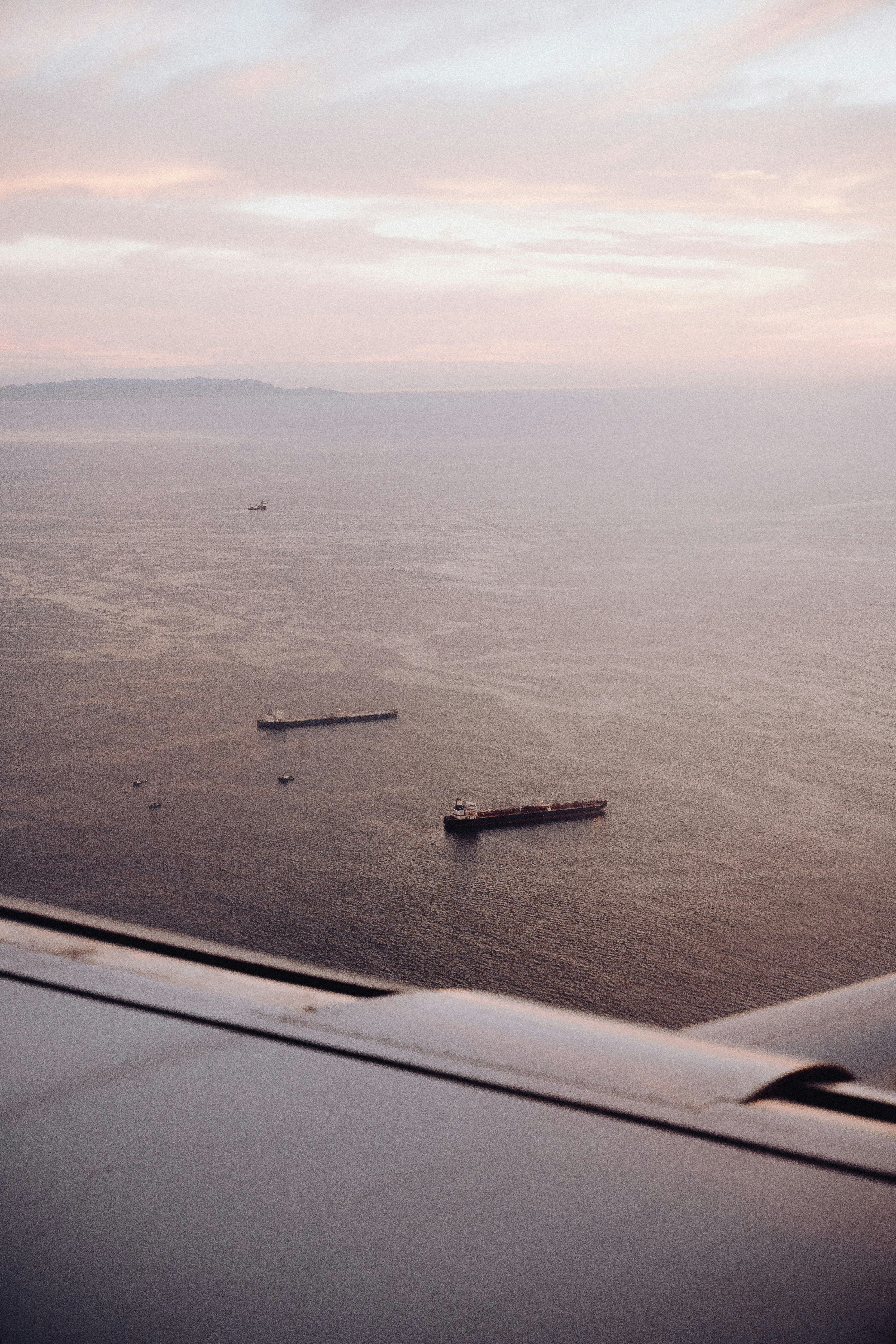 Soft Sunrise Over Quiet Harbor: Aerial View from the Wing
