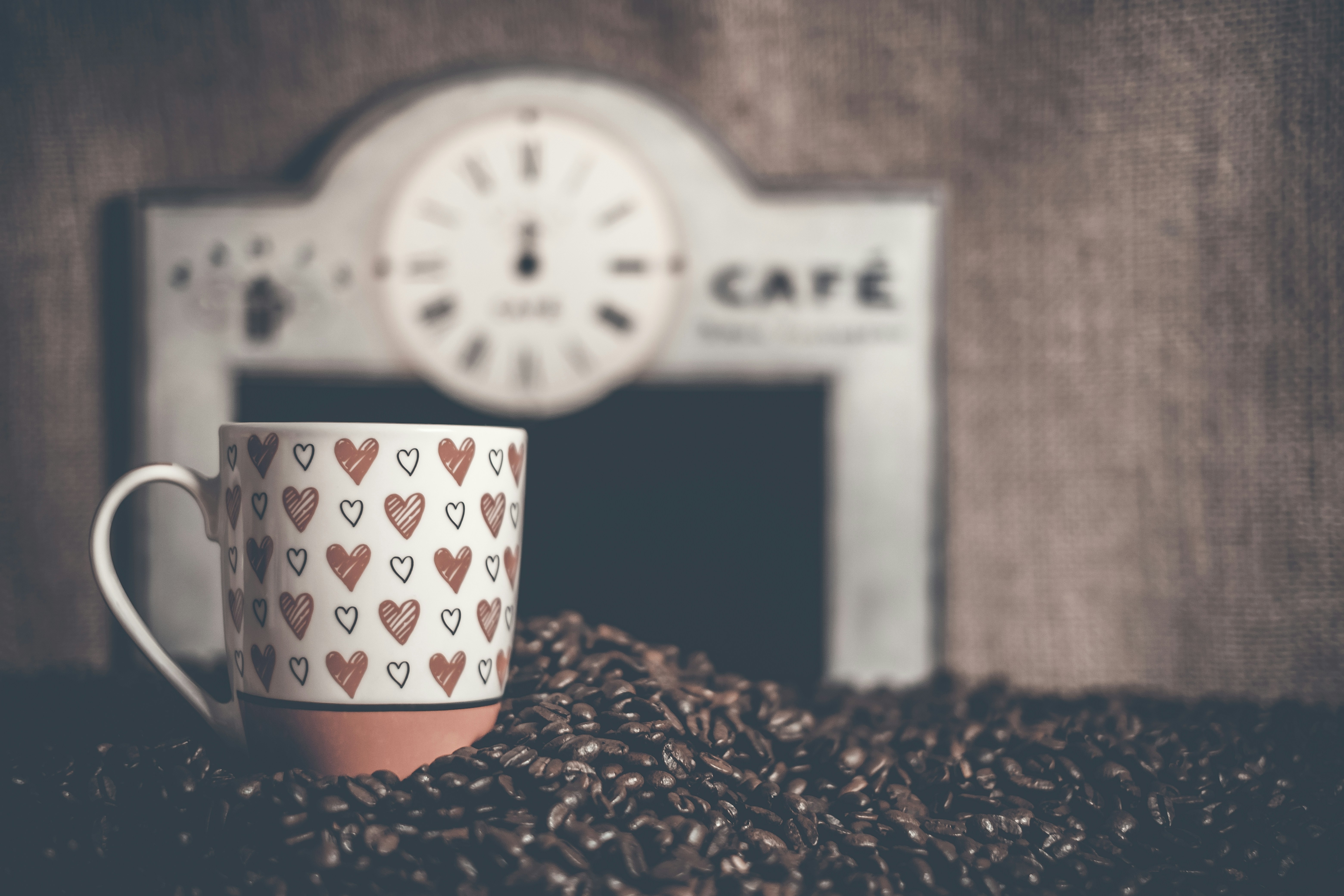 Heartfelt Steam: A Coffee Cup Among Beans