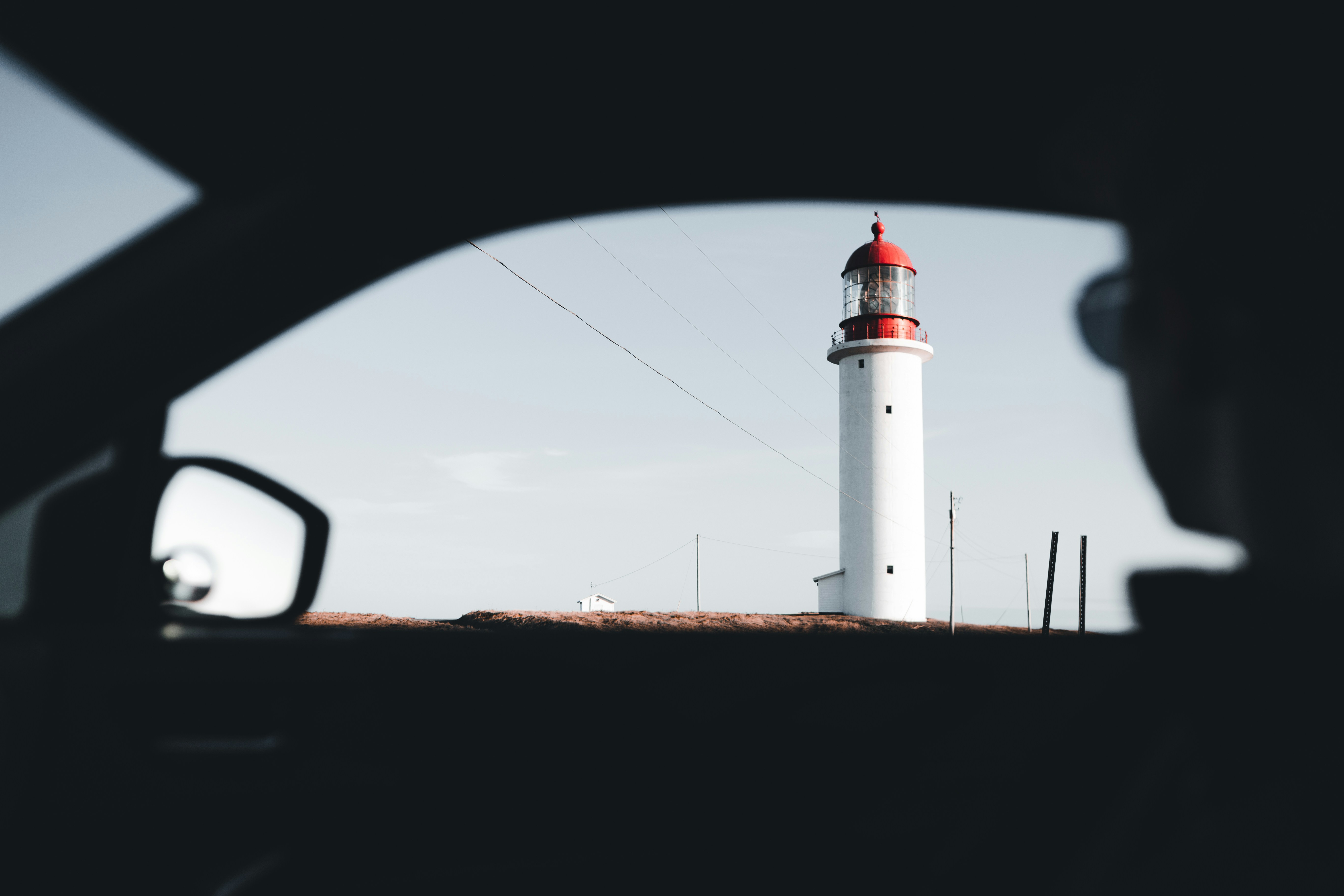 A view of a lighthouse through a car window photo – Free Grey Image on ...