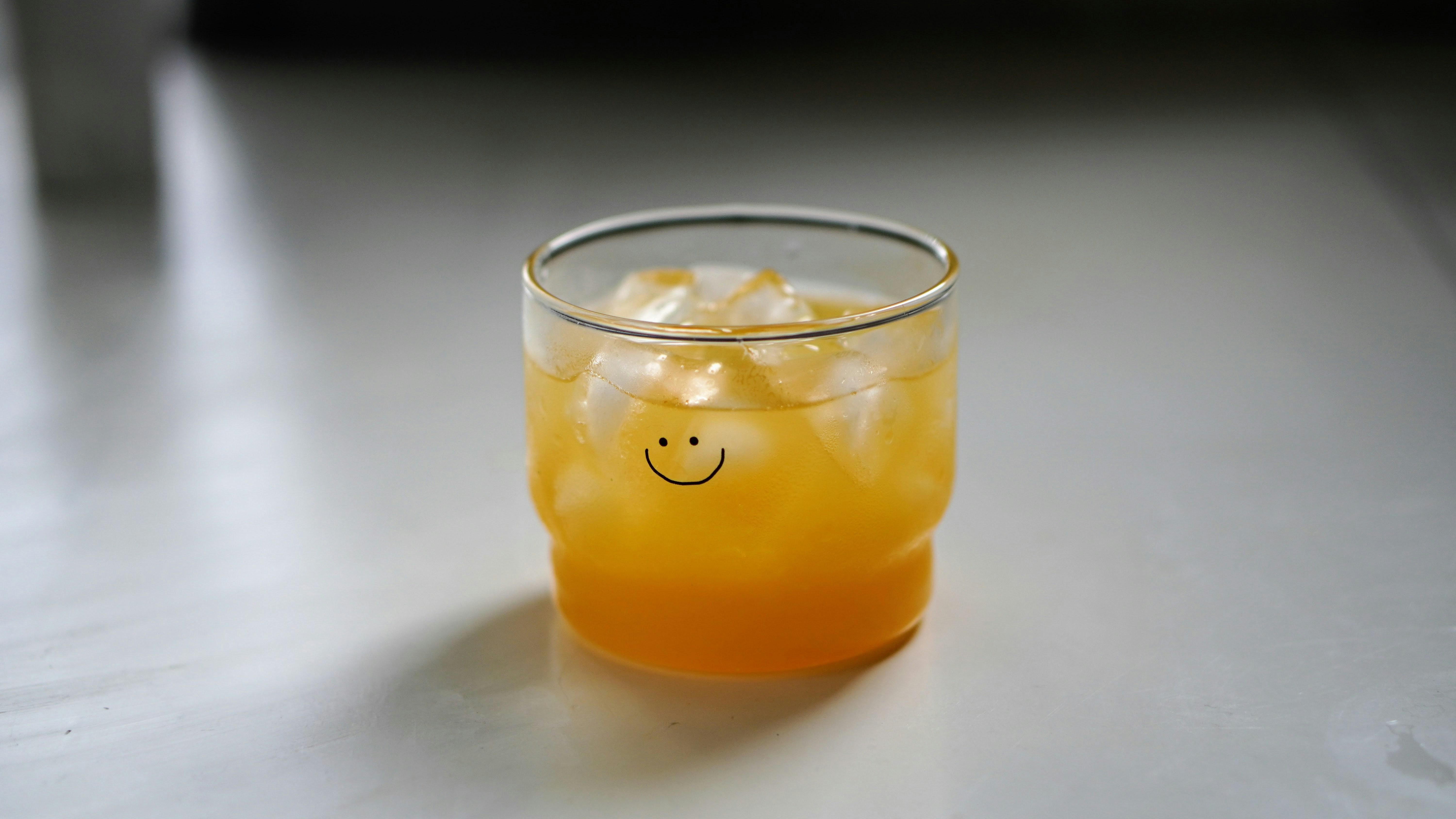 A glass of orange juice with a smiley face drawn on it photo – Free Ho ...