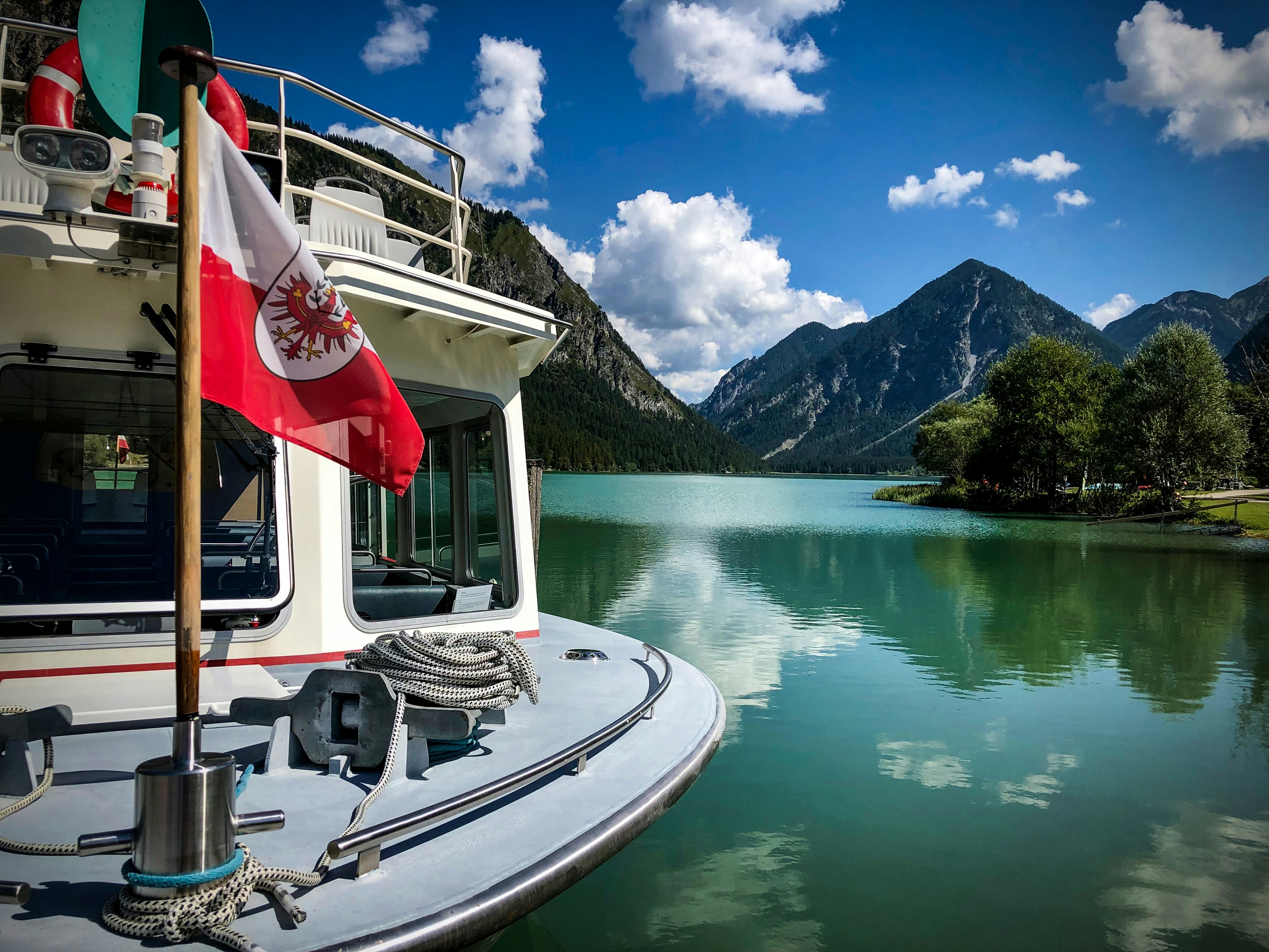 Flag on the Foredeck by an Alpine Turquoise Lake