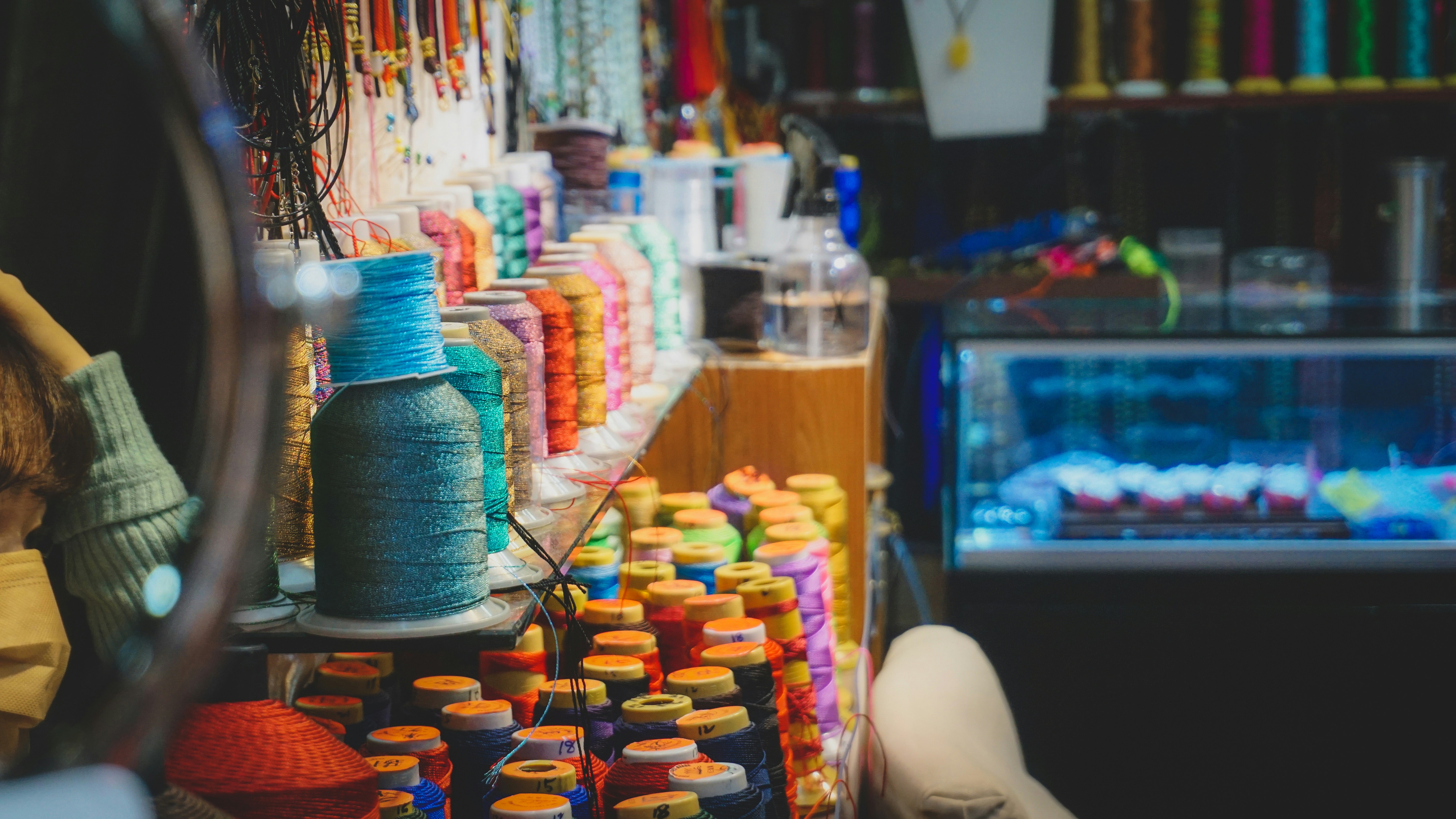 A store filled with lots of different colored spools of thread photo ...