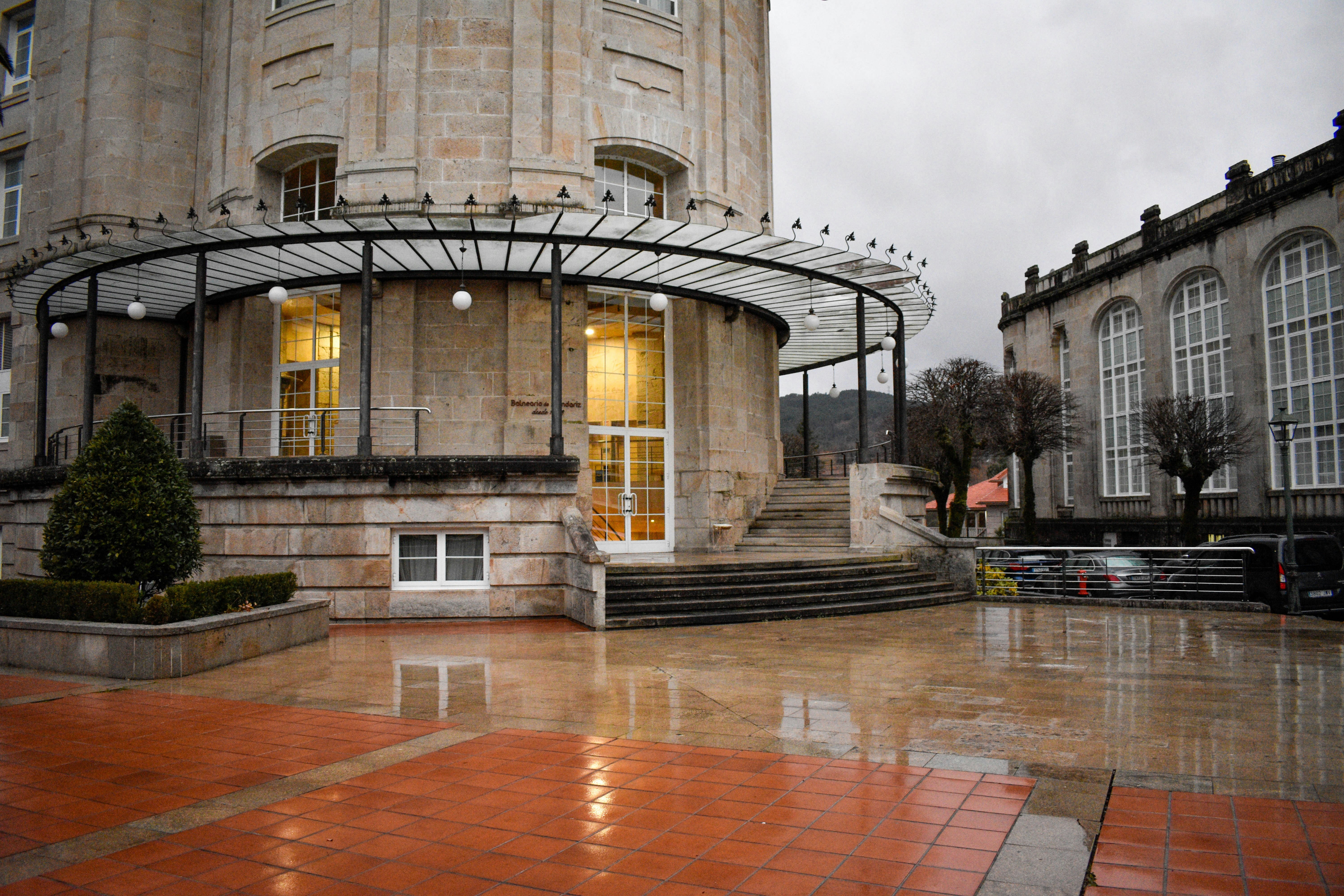 A large building with a circular entrance and steps photo – Free ...