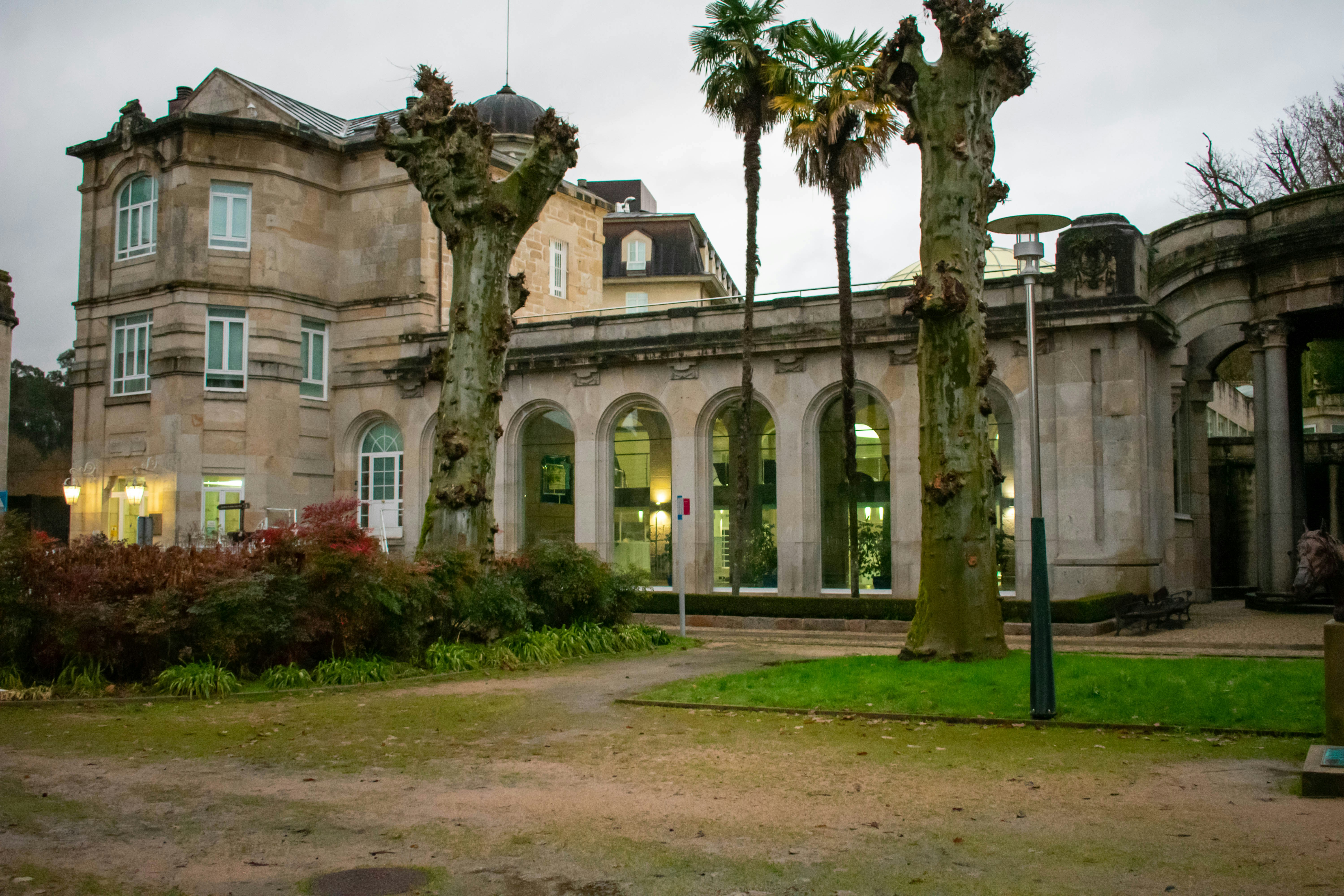 Dusk at the Colonnade: Historic Arches Framed by Pollarded Trees