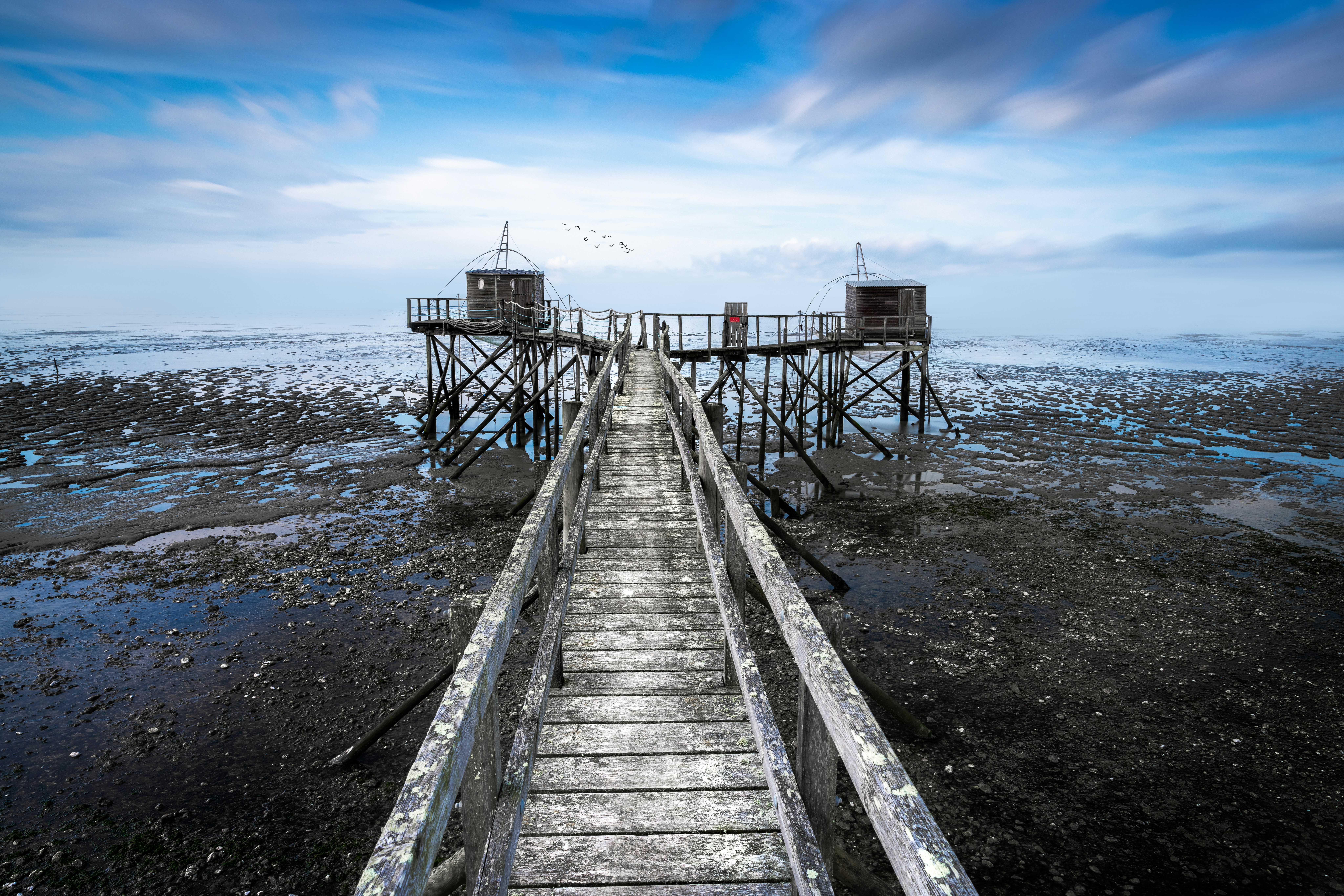 A pier with two water towers on top of it photo – Free Beach Image on ...